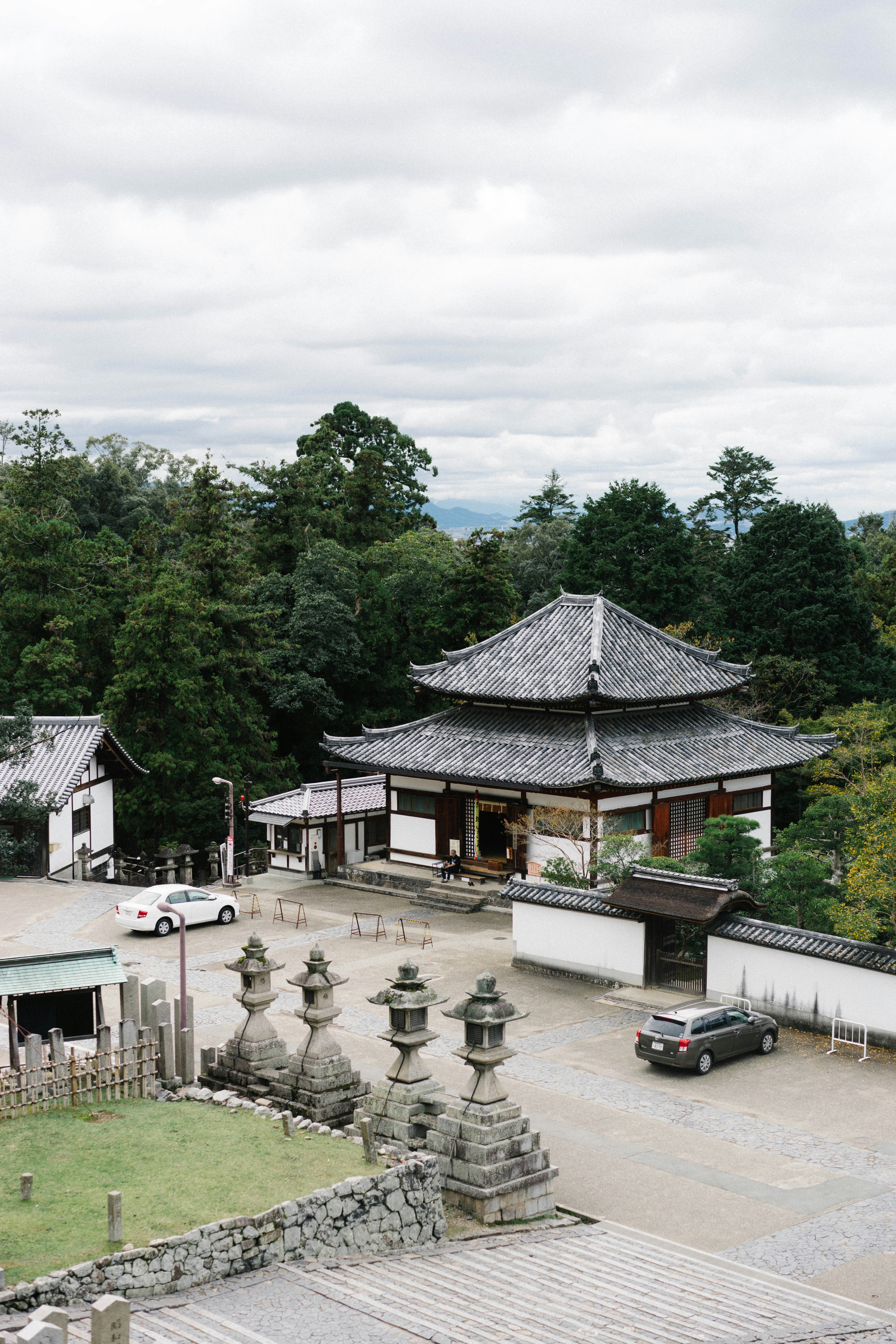 Temple Rooflines and Stone Lanterns at a Secluded Forest Courtyard
