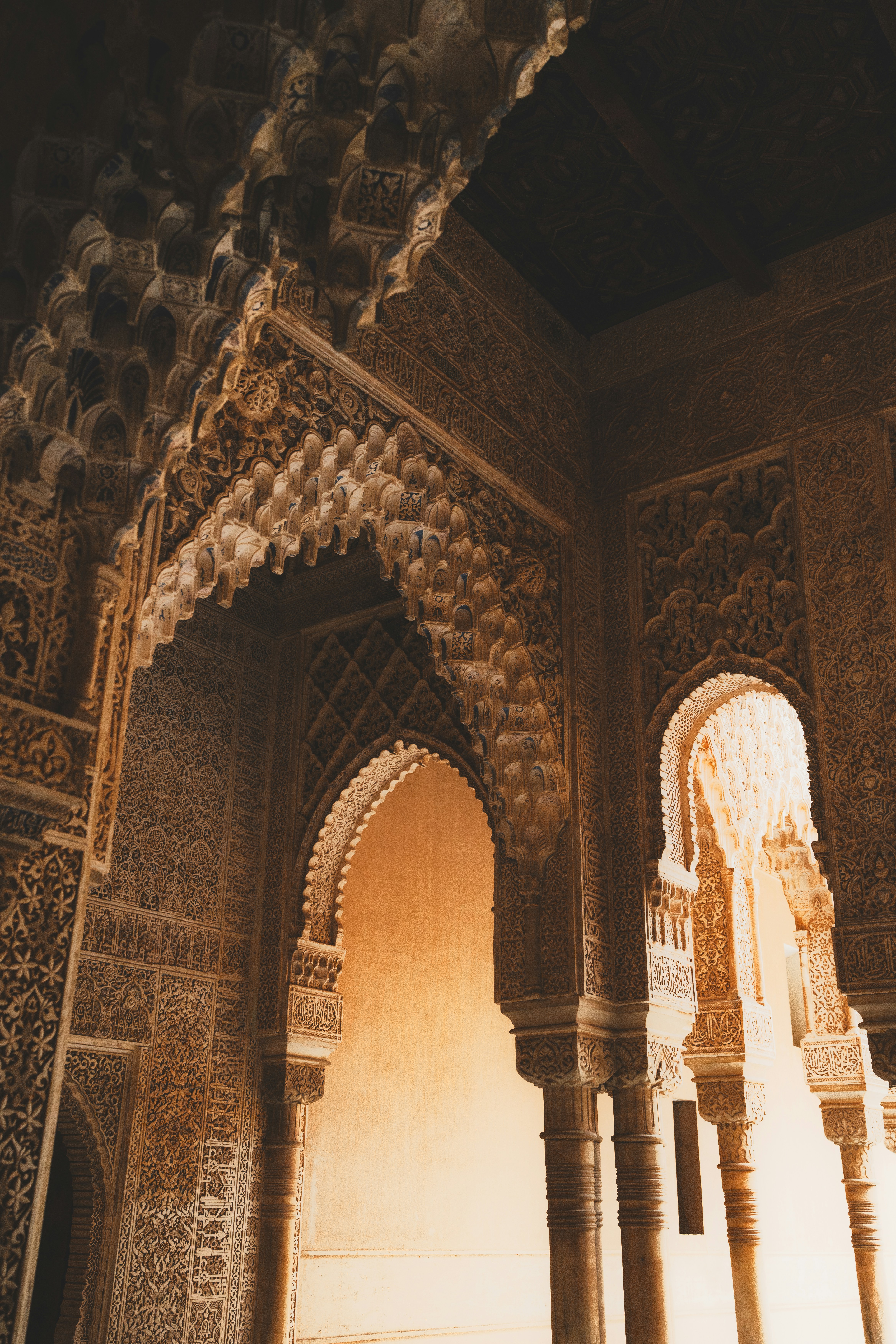 A building with a large archway and a clock on the wall photo – Free ...