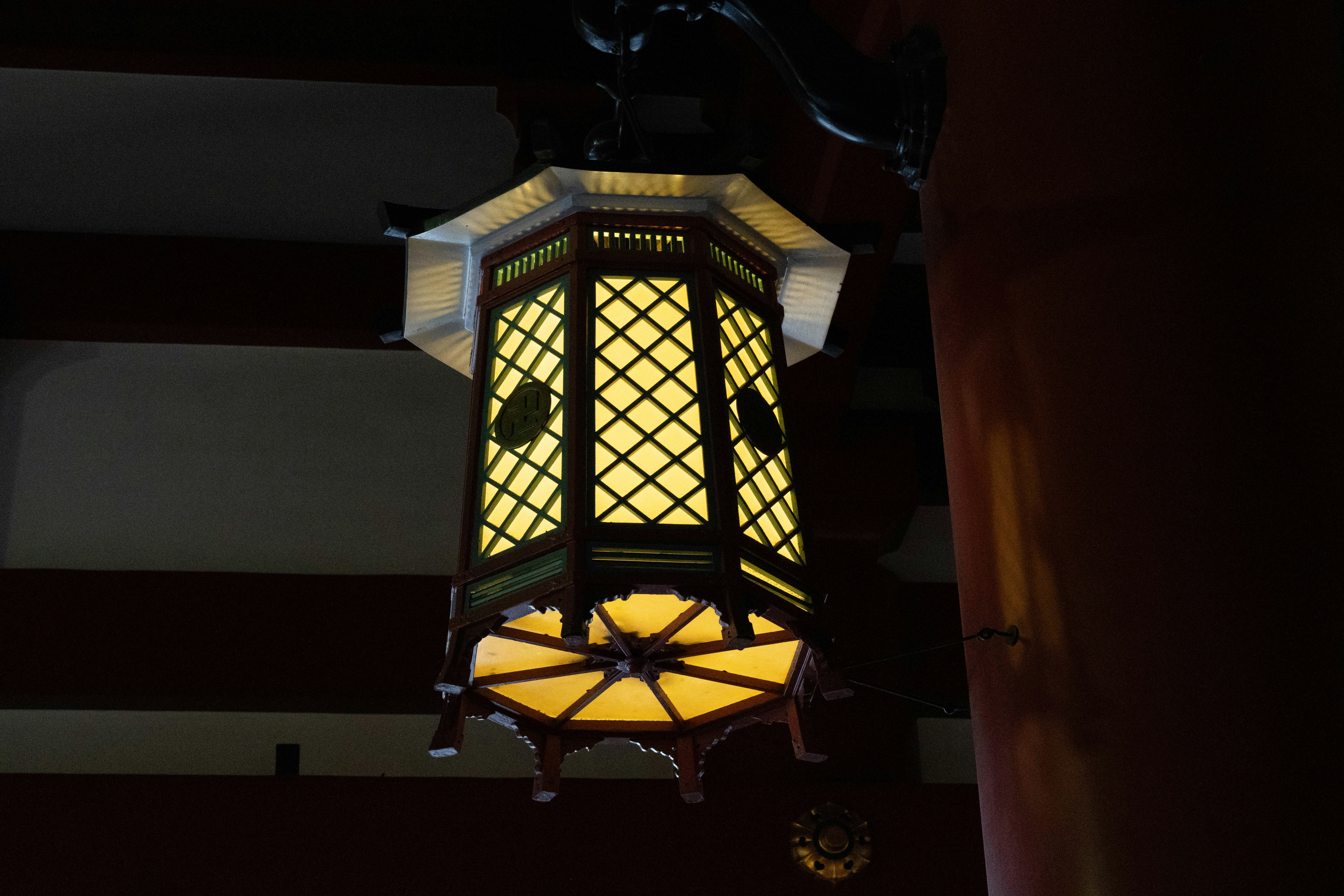 A lamp hanging from the ceiling of a building