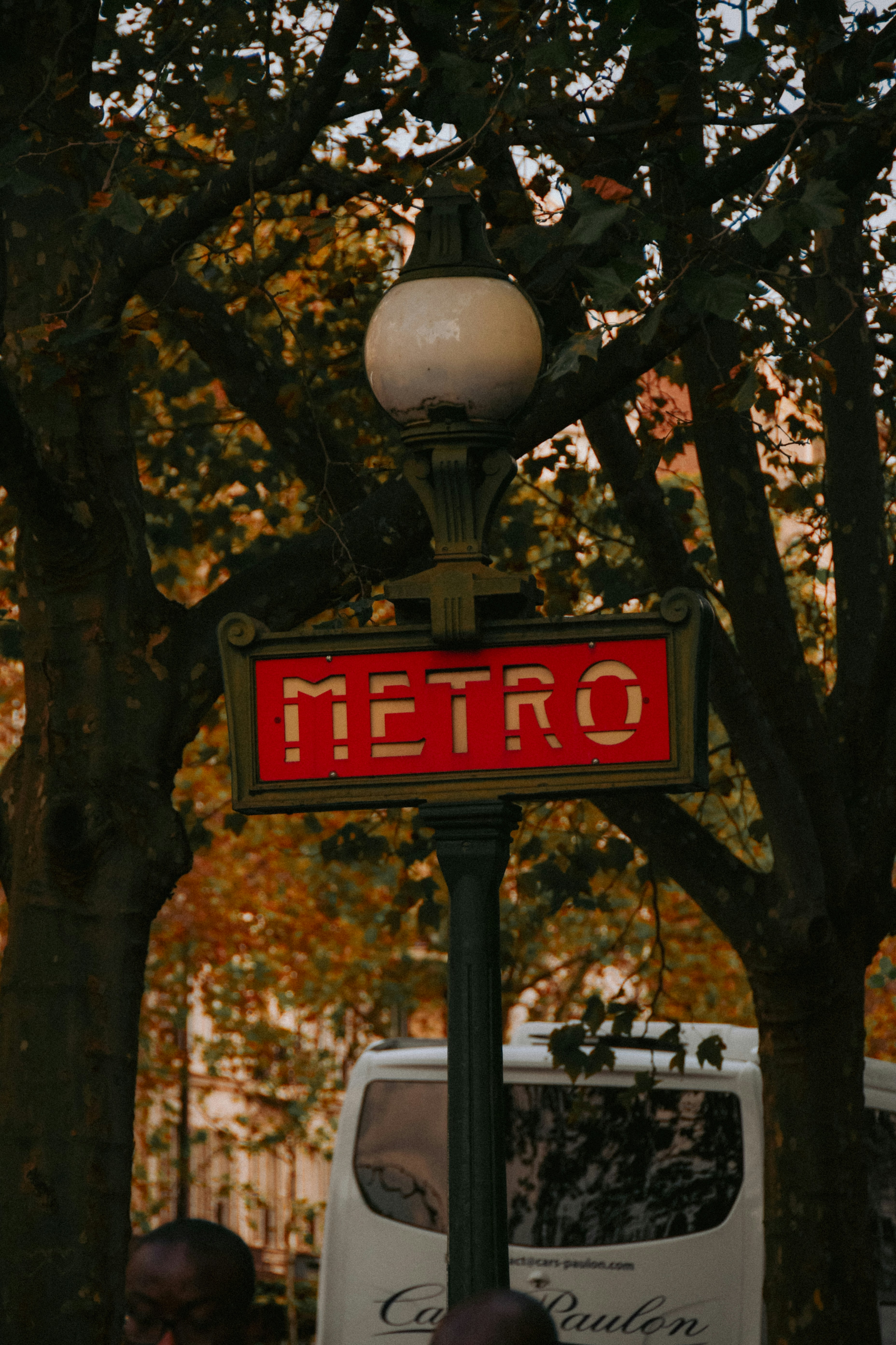 A red metro sign sitting on the side of a road photo – Free Paris Image ...