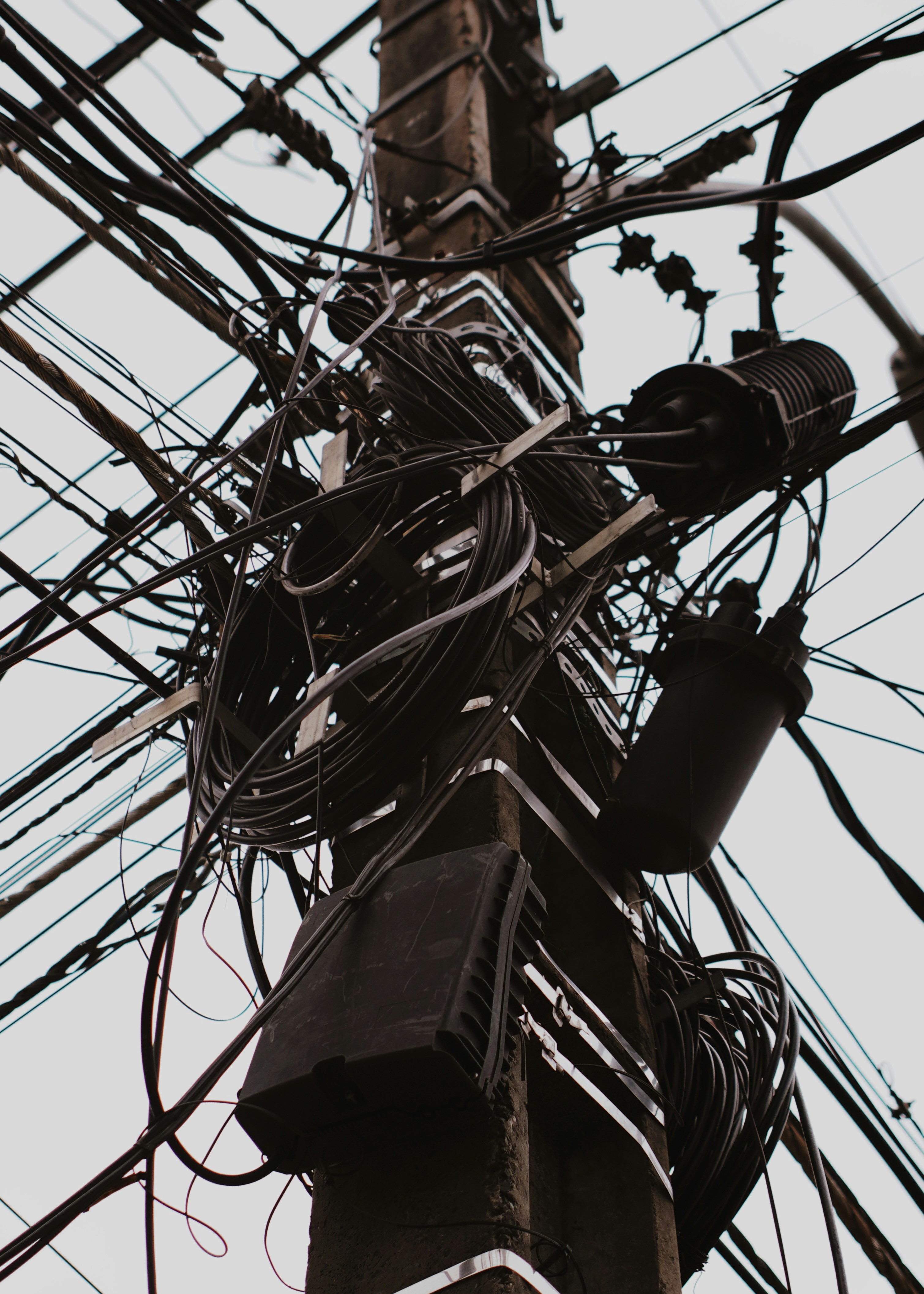 A telephone pole covered in lots of wires and wires photo – Free Tech ...