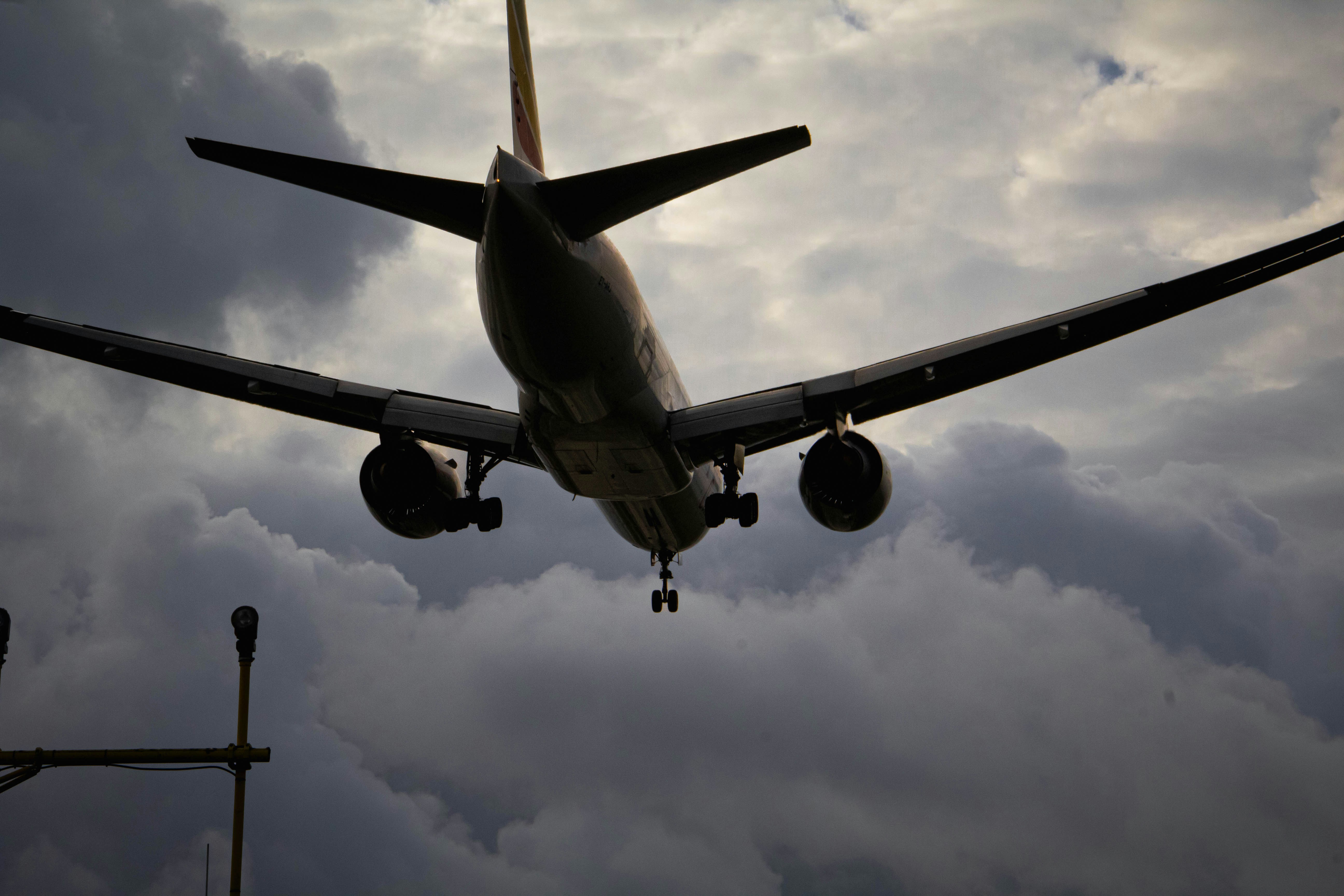 Underbelly Descent: A Jet Emerges Through Stormy Skies