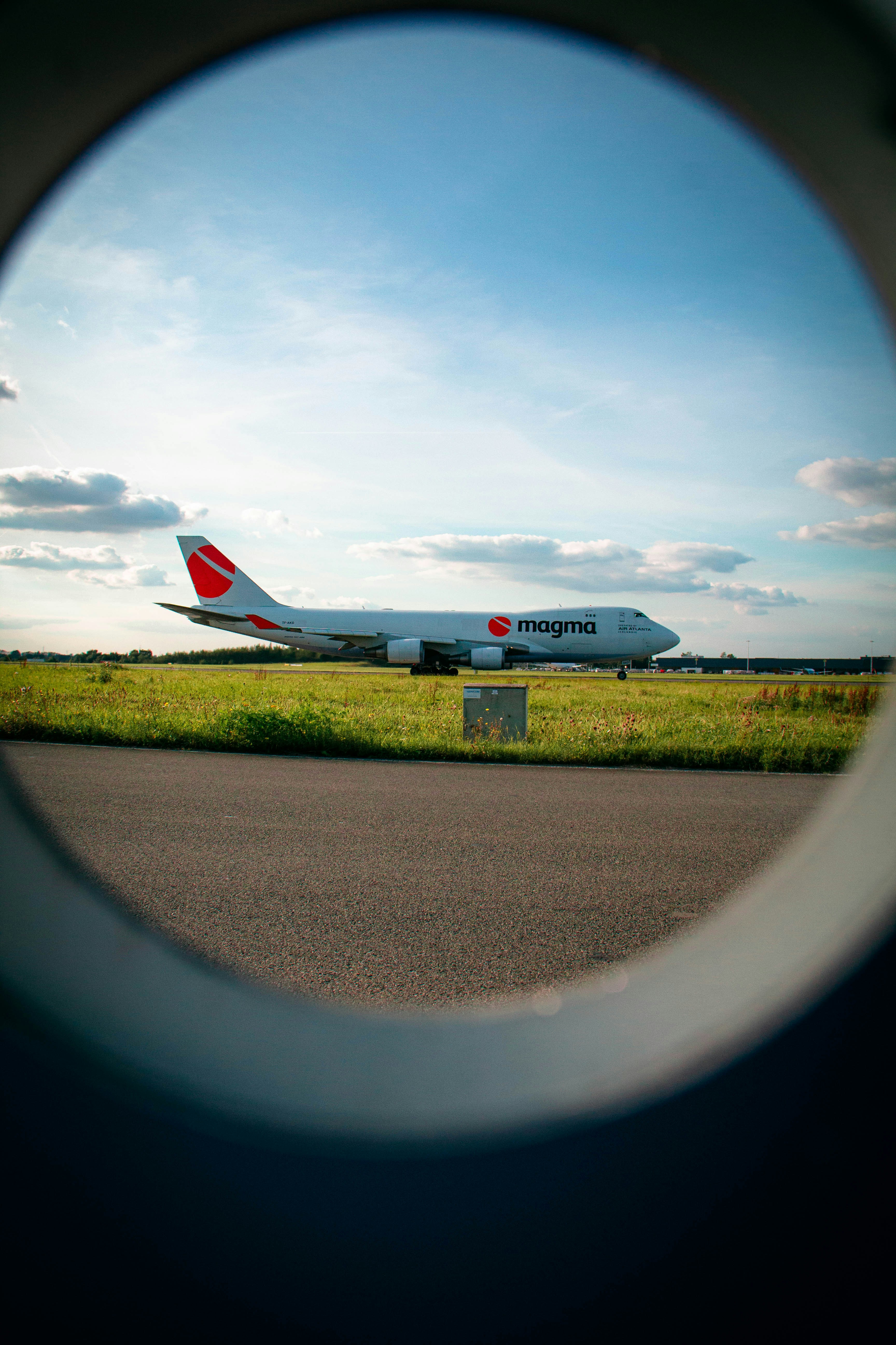 Magma Jet Framed by a Circular Window on a Sunlit Runway