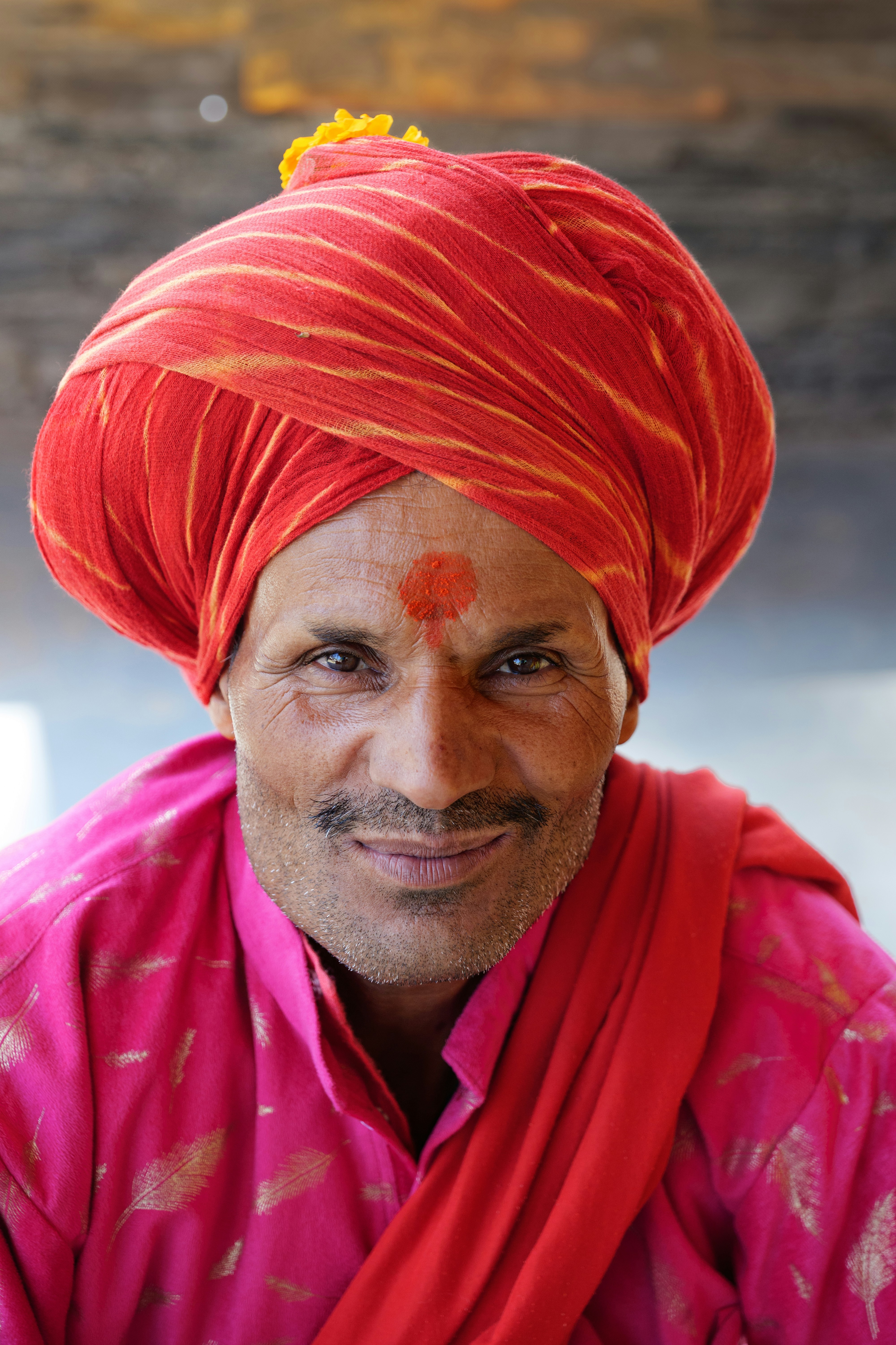 turban | A man in a red turban smiles for the camera