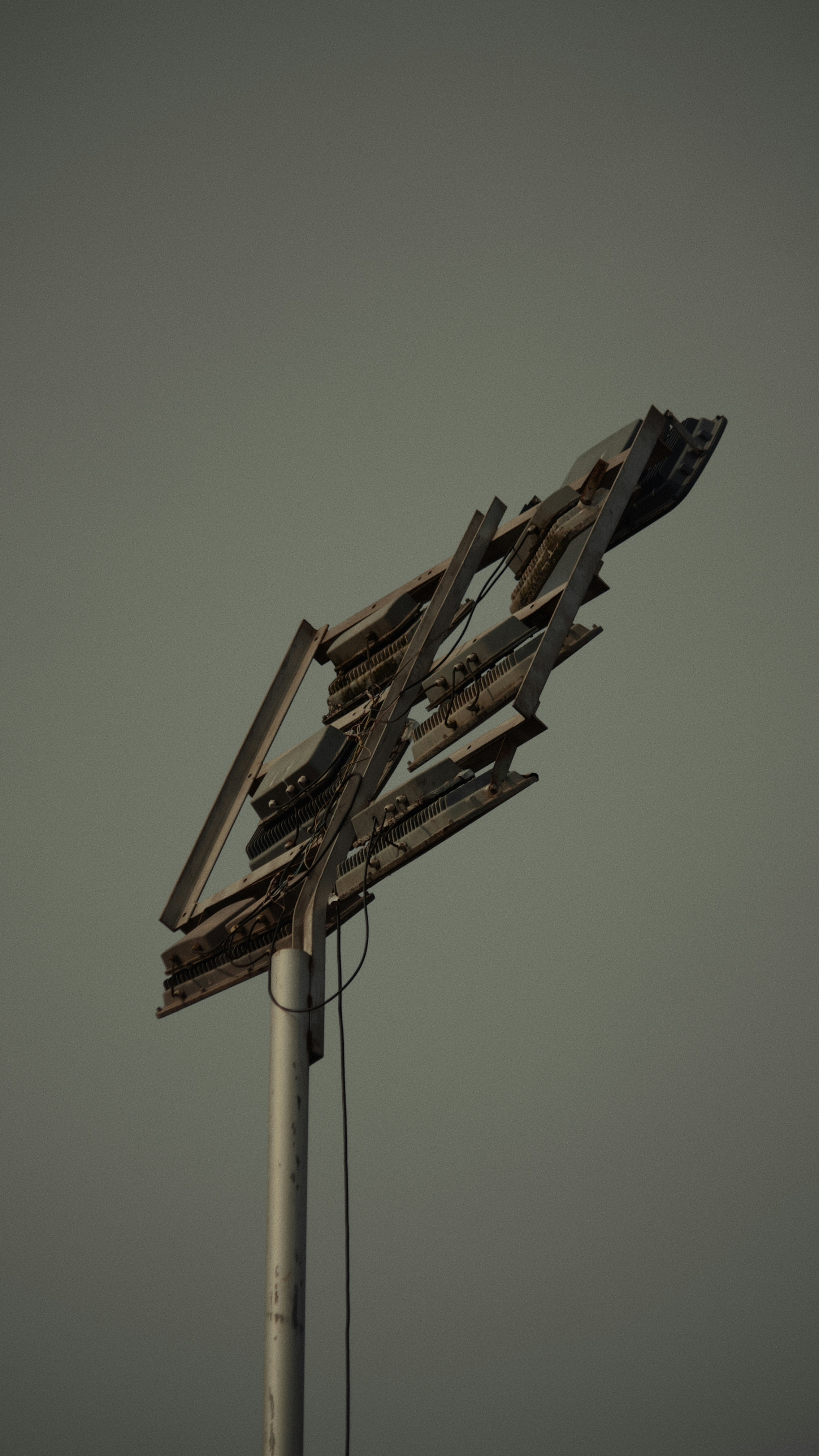 Leaning Signwork: Rusted Slats Reaching Toward a Quiet Sky