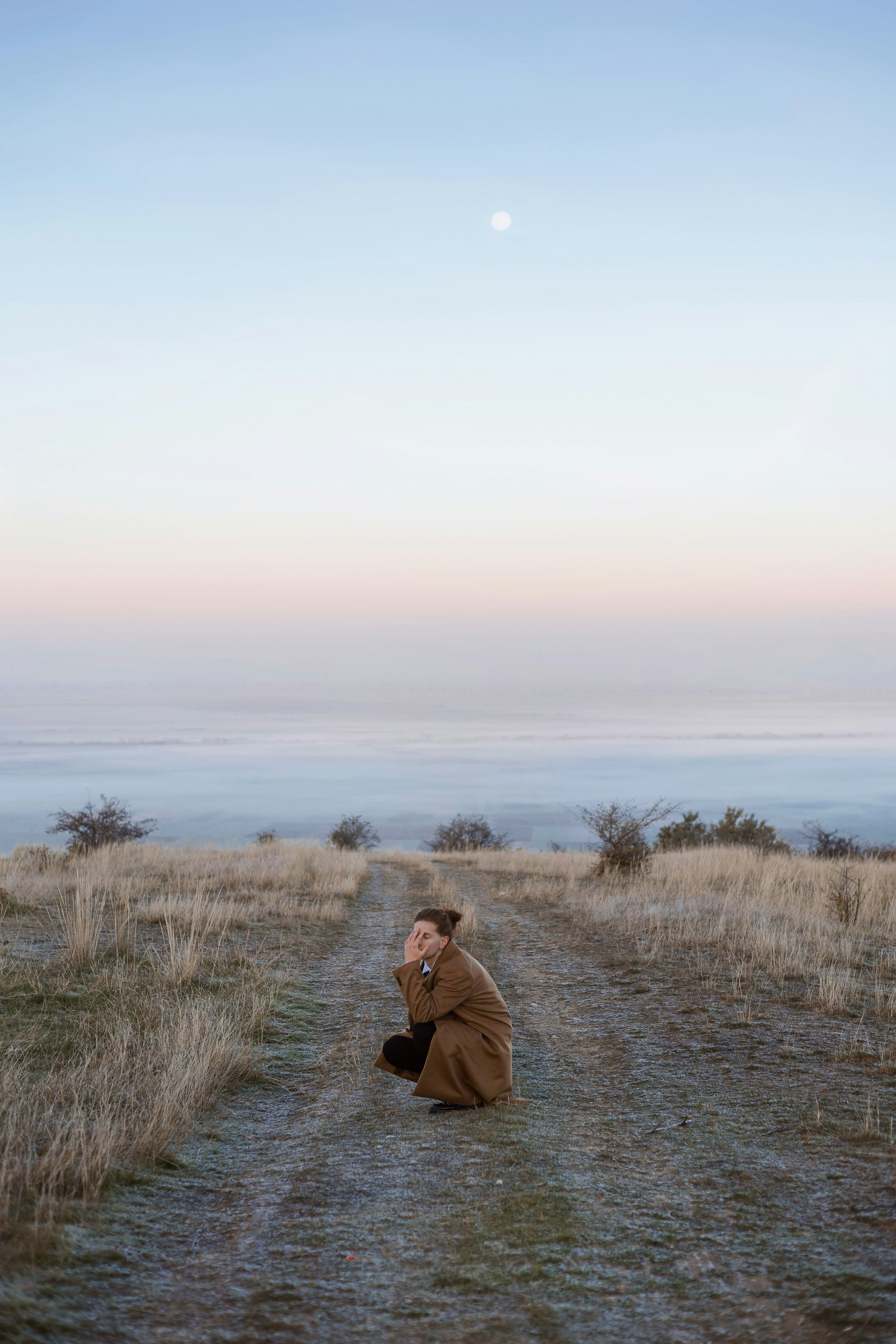 Dusk on the Prairie Path: A Lone Figure in a Warm Coat