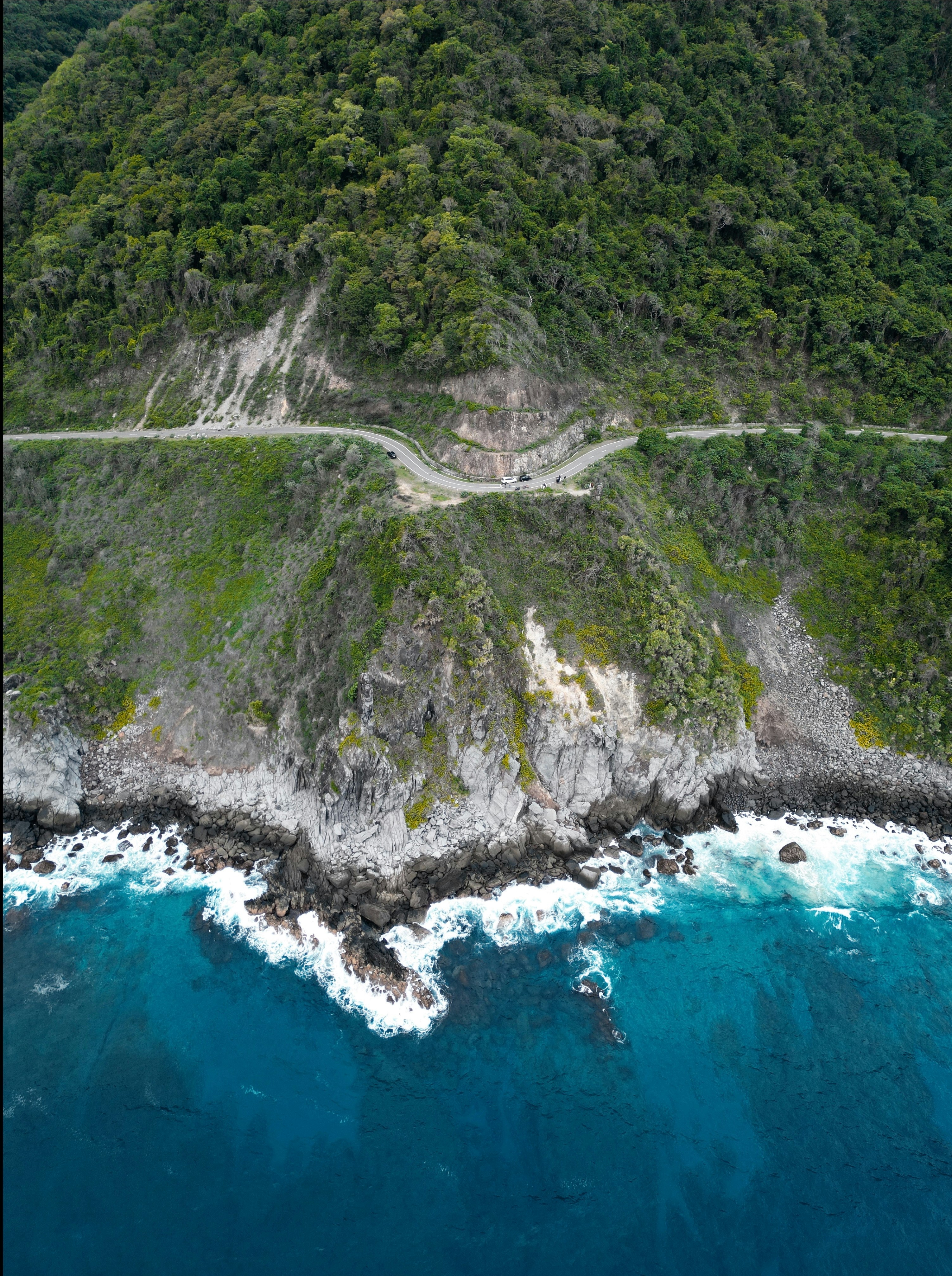 Ribbon of the Cliff: a winding road threading emerald slopes above turquoise surf