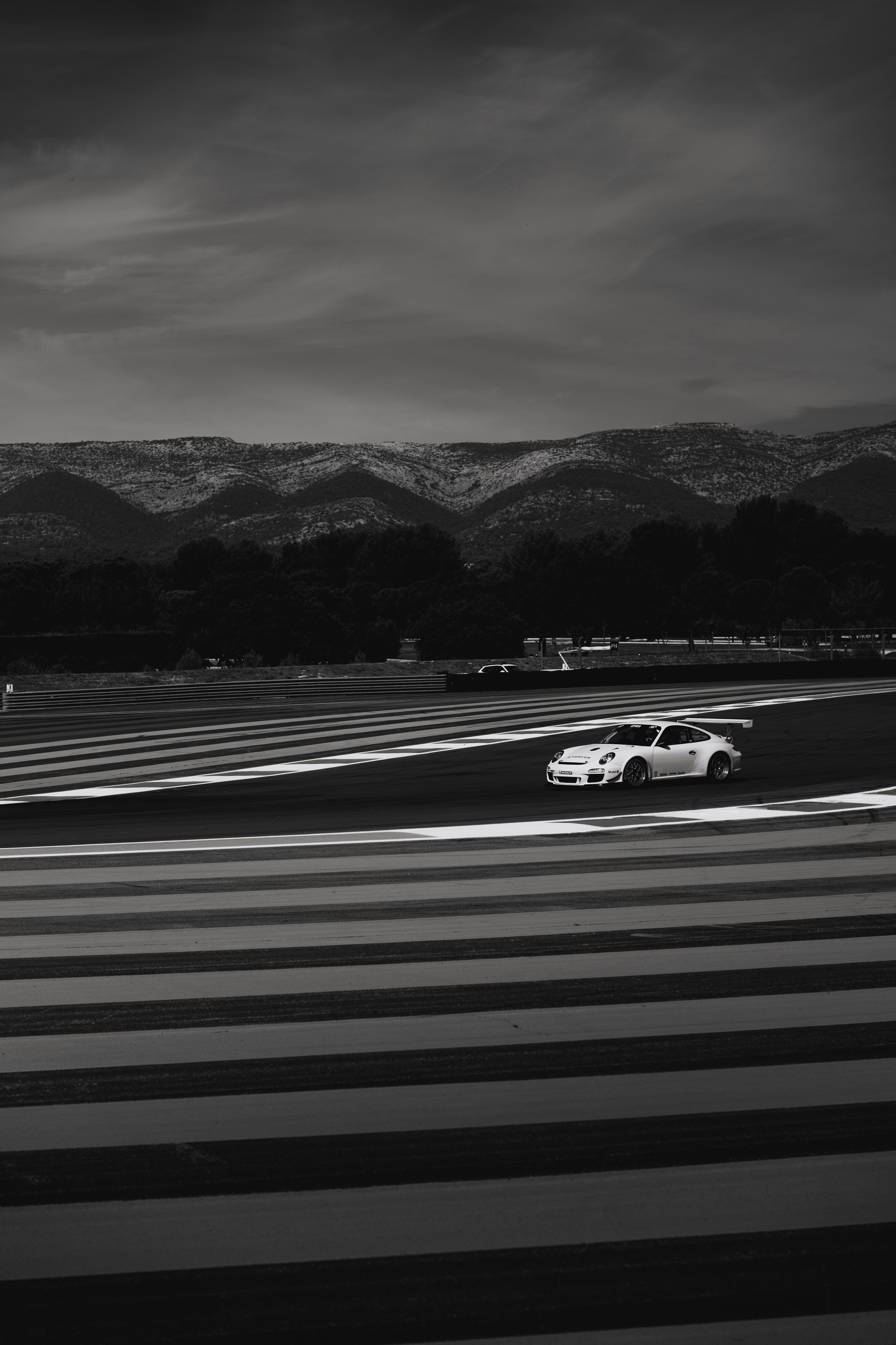 A black and white photo of a car driving down a road photo – Free Car ...