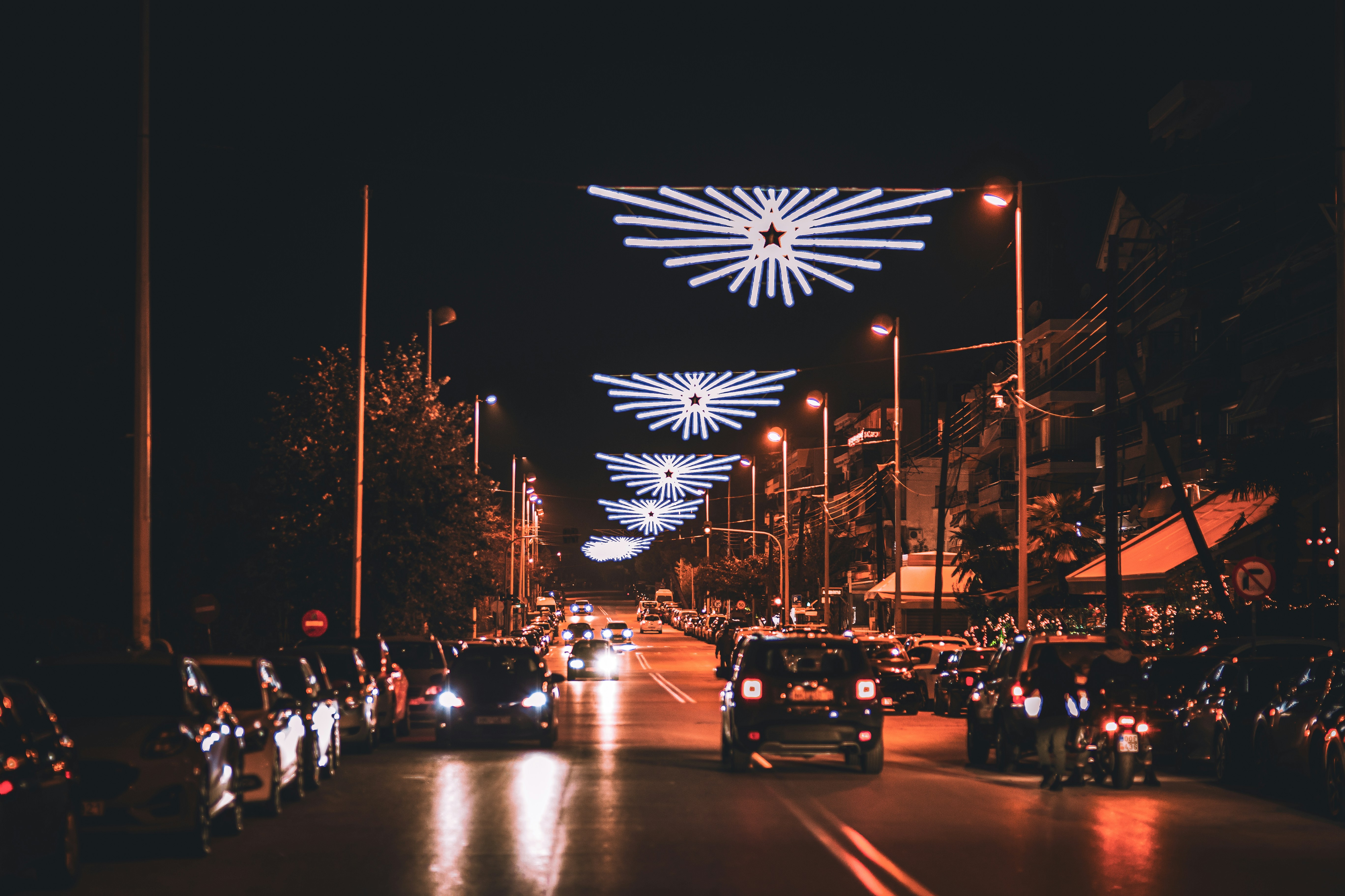 Starburst Streetlights: A Night Drive Beneath Neon Snowflake Fixtures