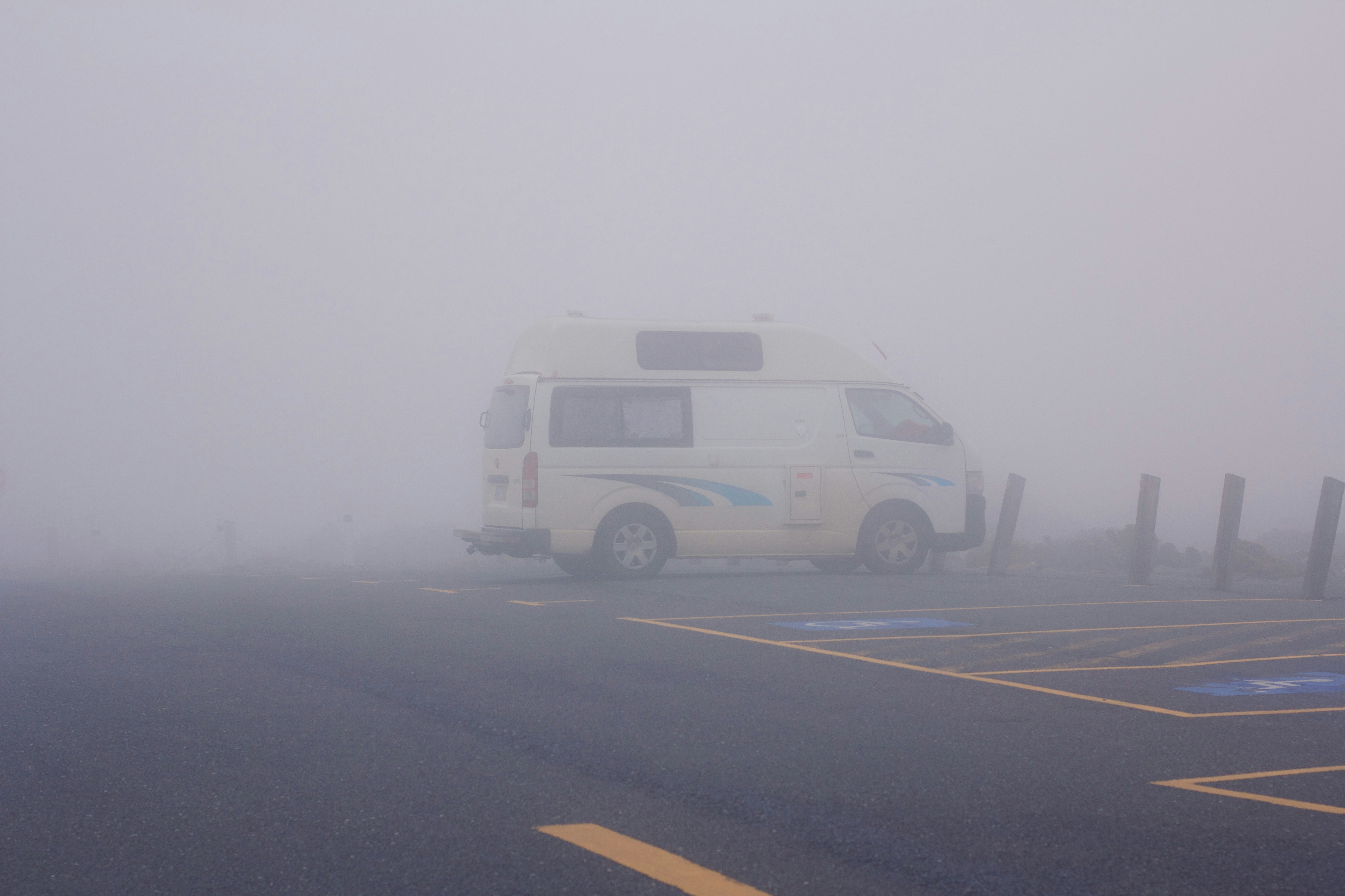 Vanishing Horizon: The Minivan in Misty Silence