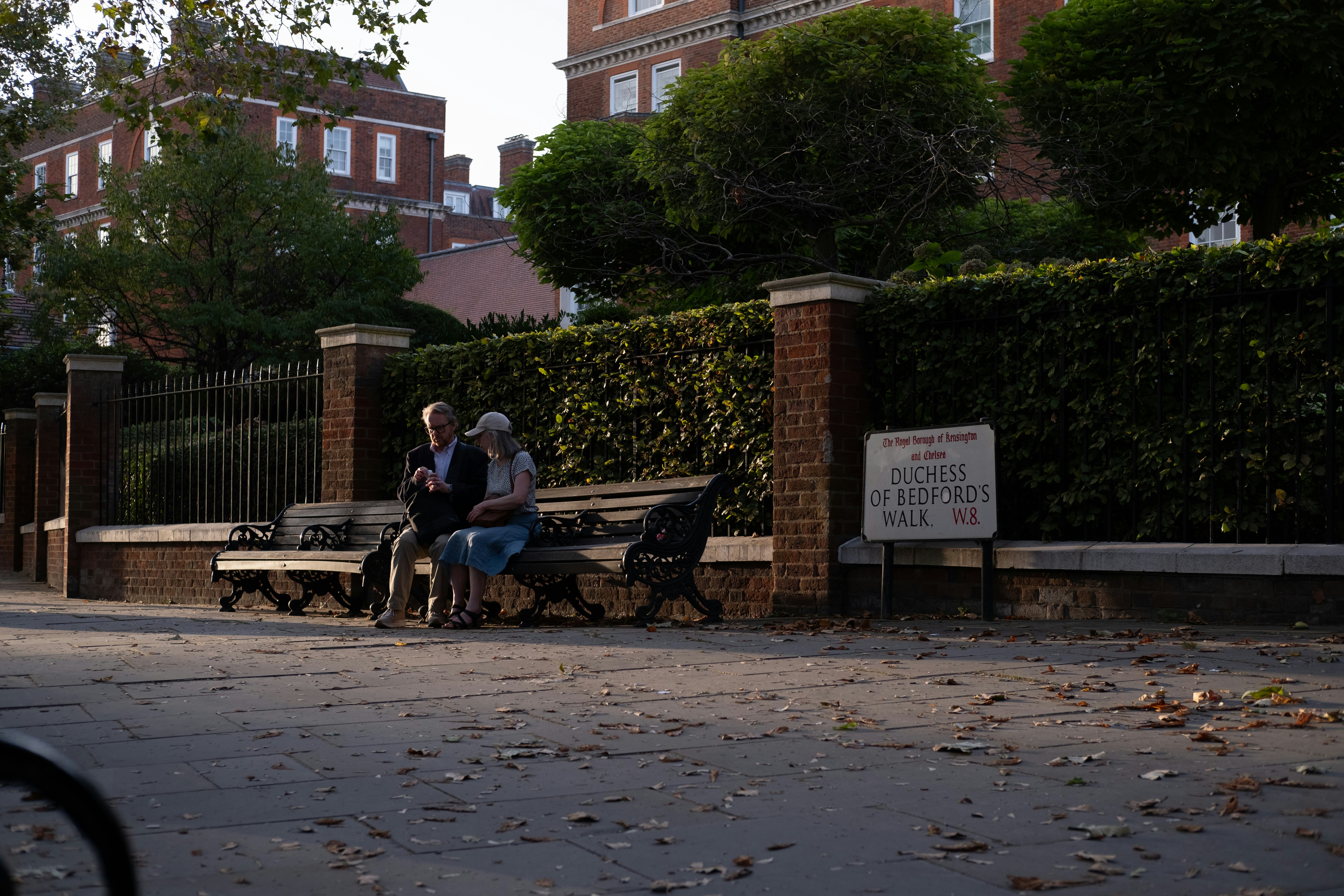 Quiet Bench Conversation Under a Brick Veranda