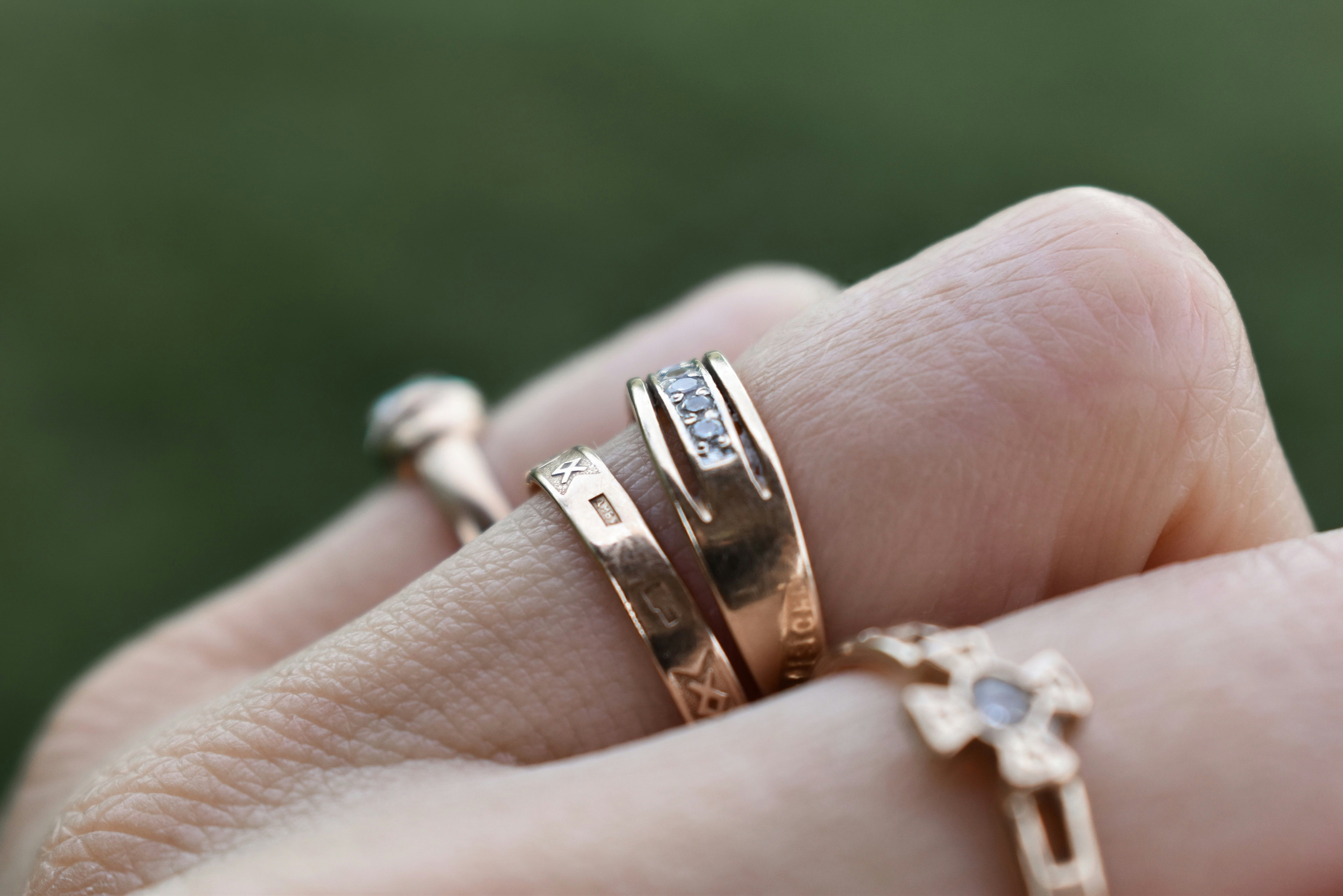 A close up of a person's hand holding two rings photo – Free Jewelry ...