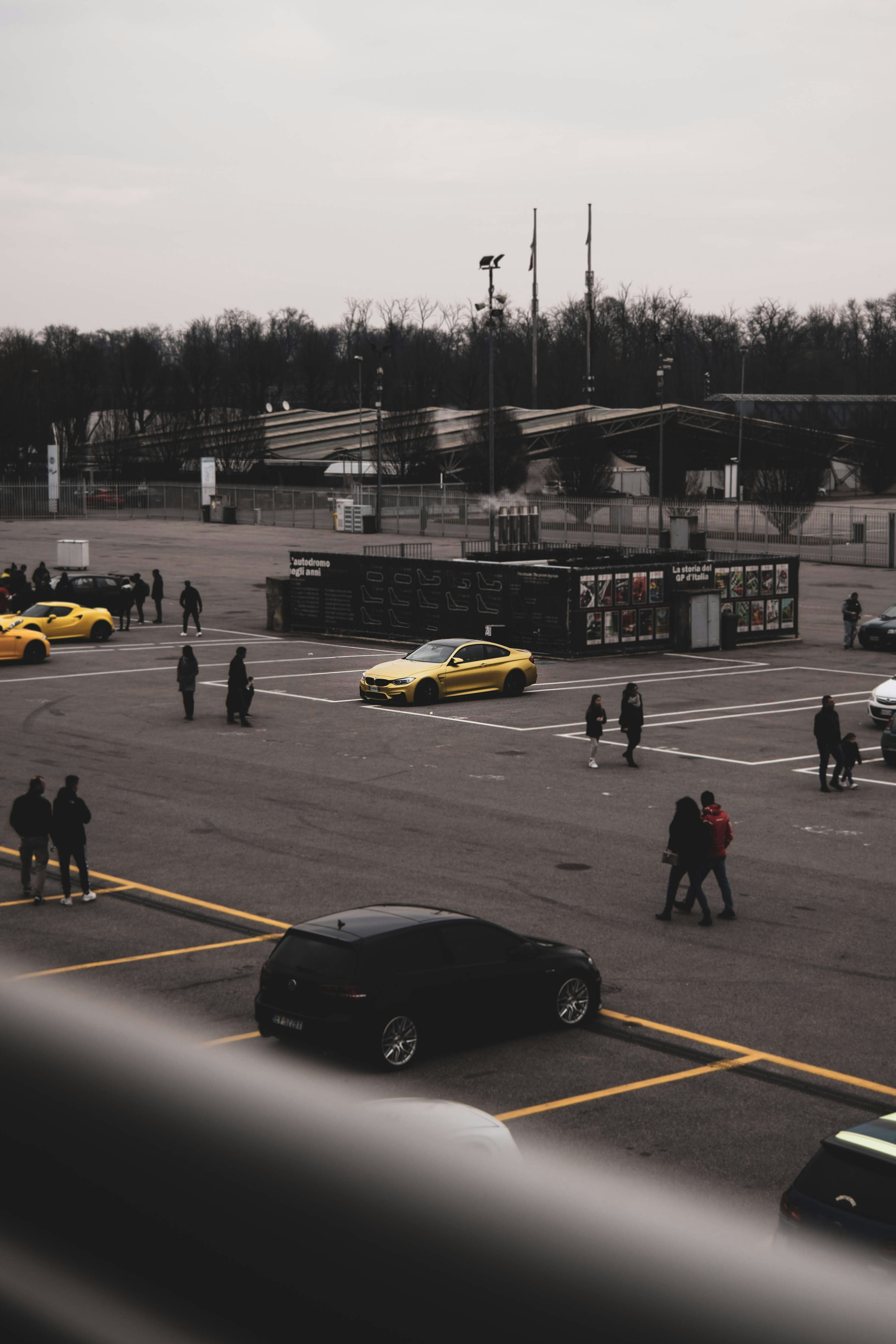 Yellow Spotlight in a Quiet Parking Lot Under Grey Skies