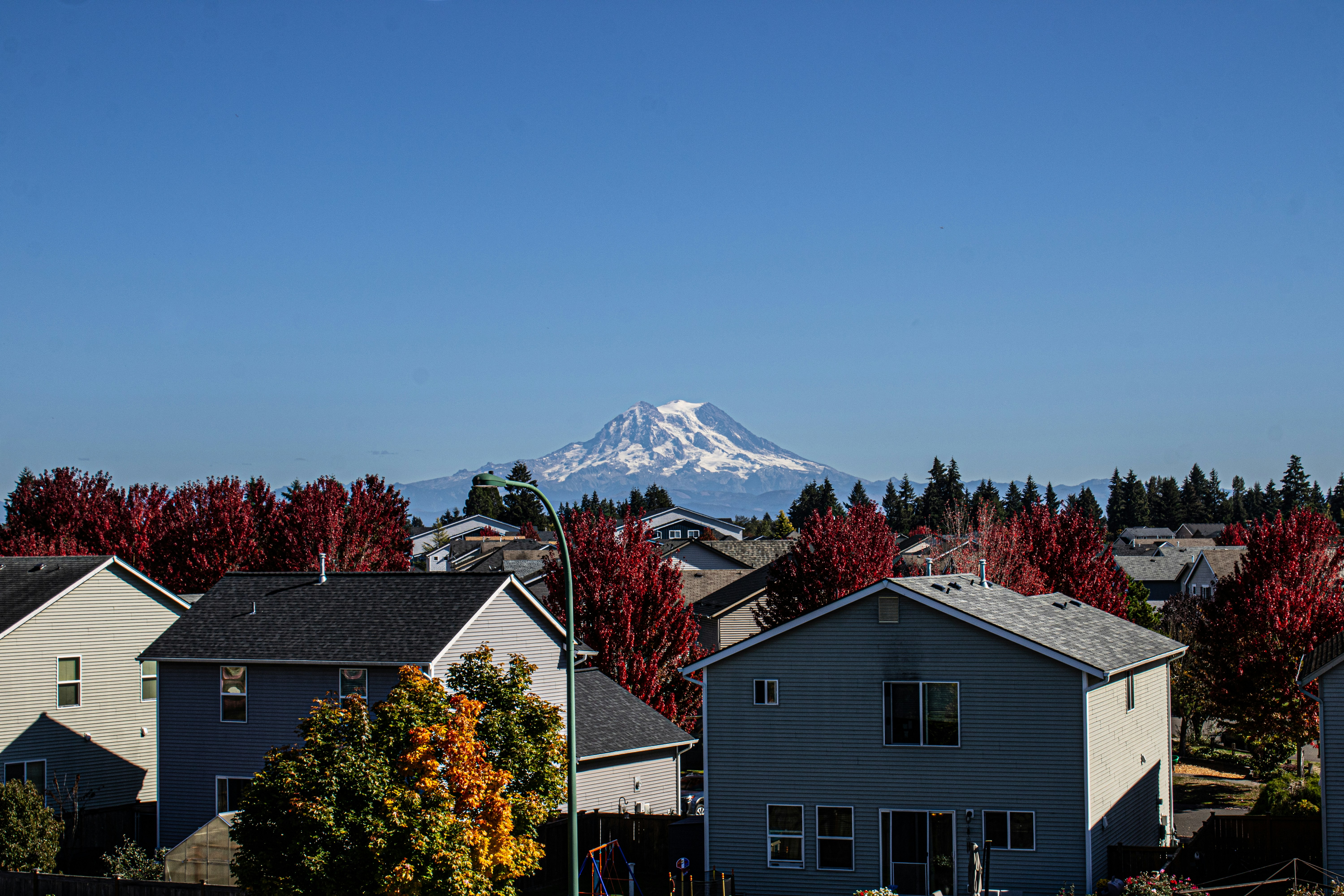 Snowbound Summit Over a Quiet Suburban Autumn