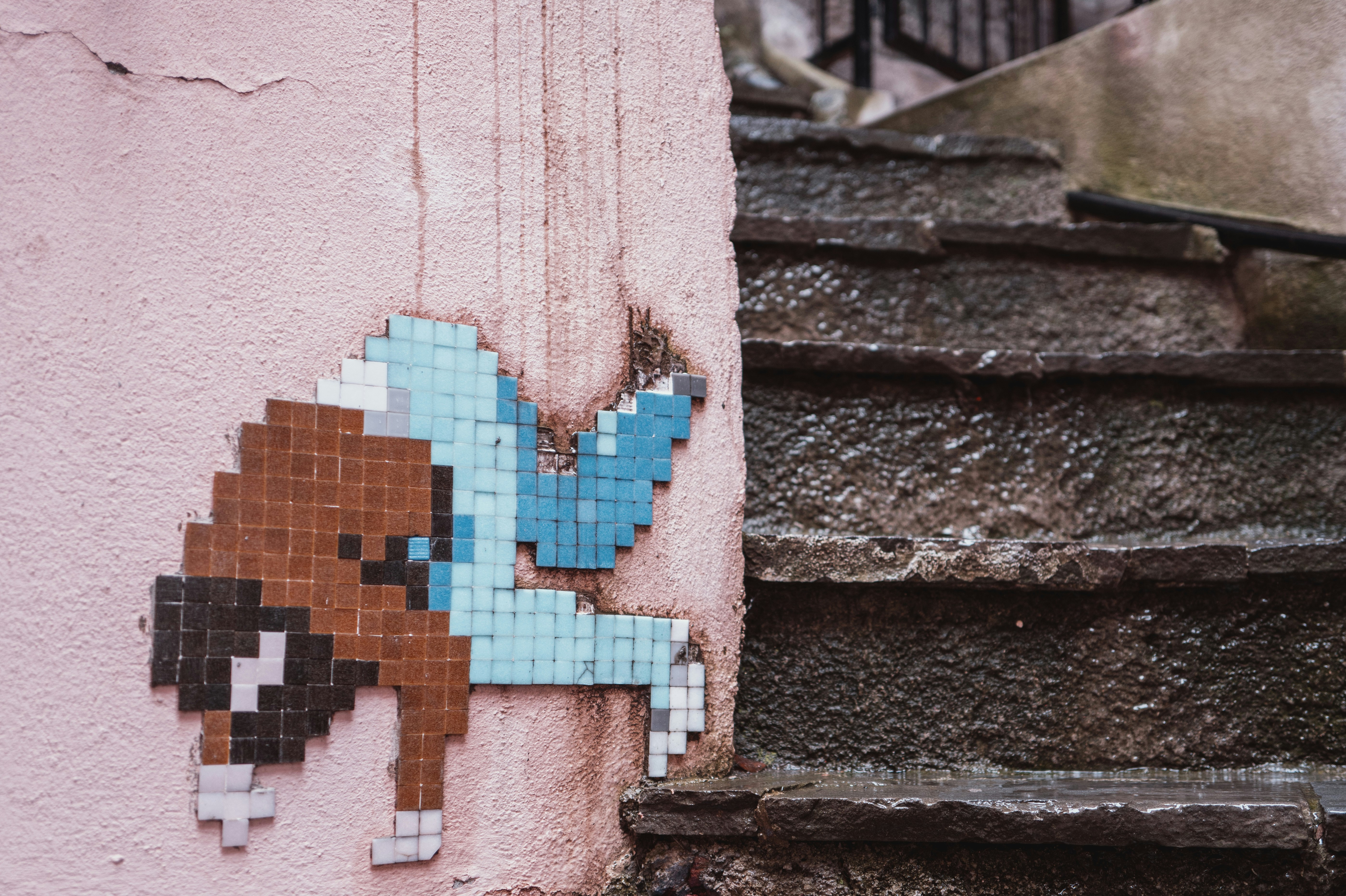 Pastel Pixel Horse on a Pink Wall Beside Weathered Steps