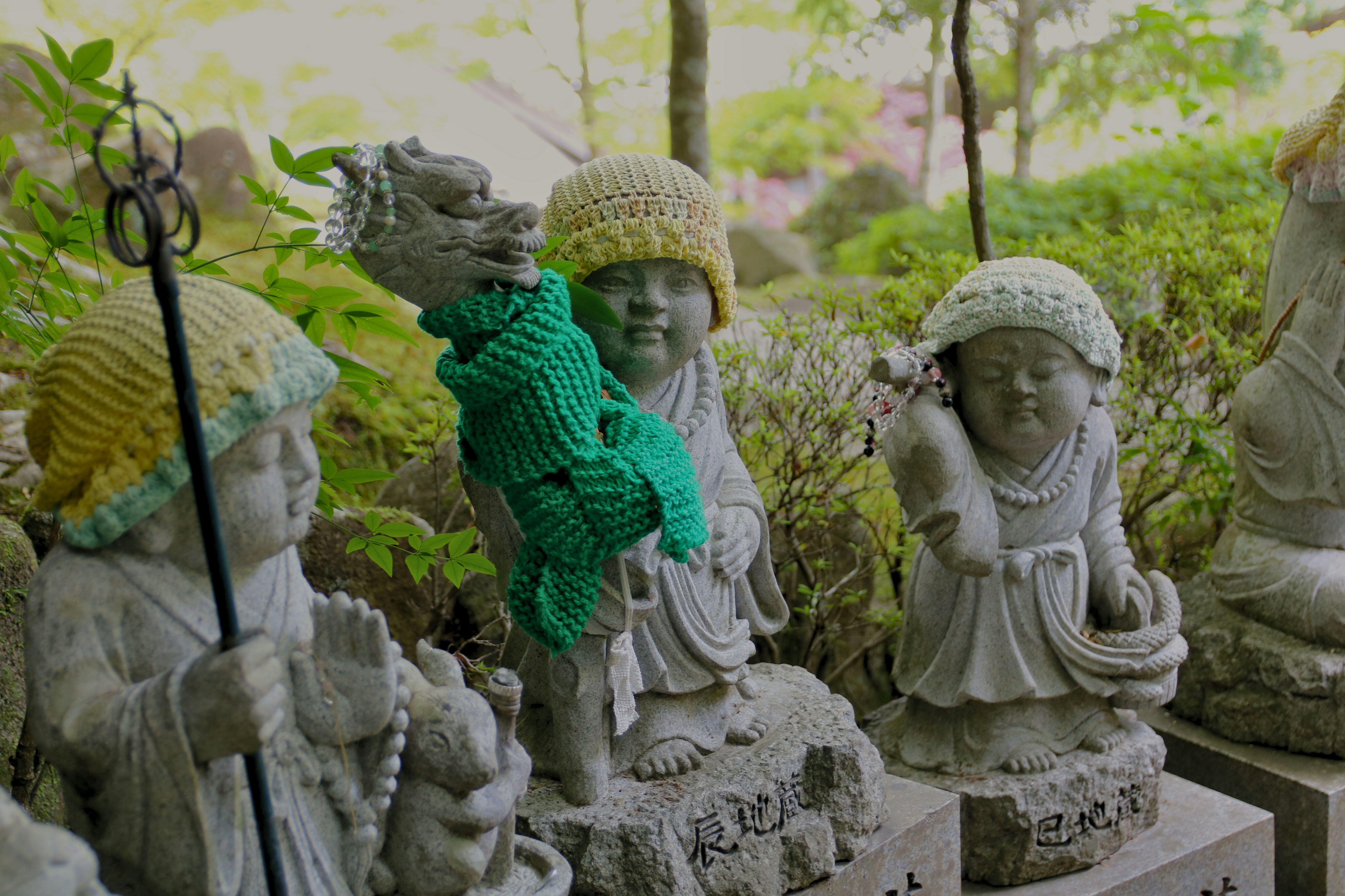 A group of statues sitting on top of cement blocks photo – Free Japan ...