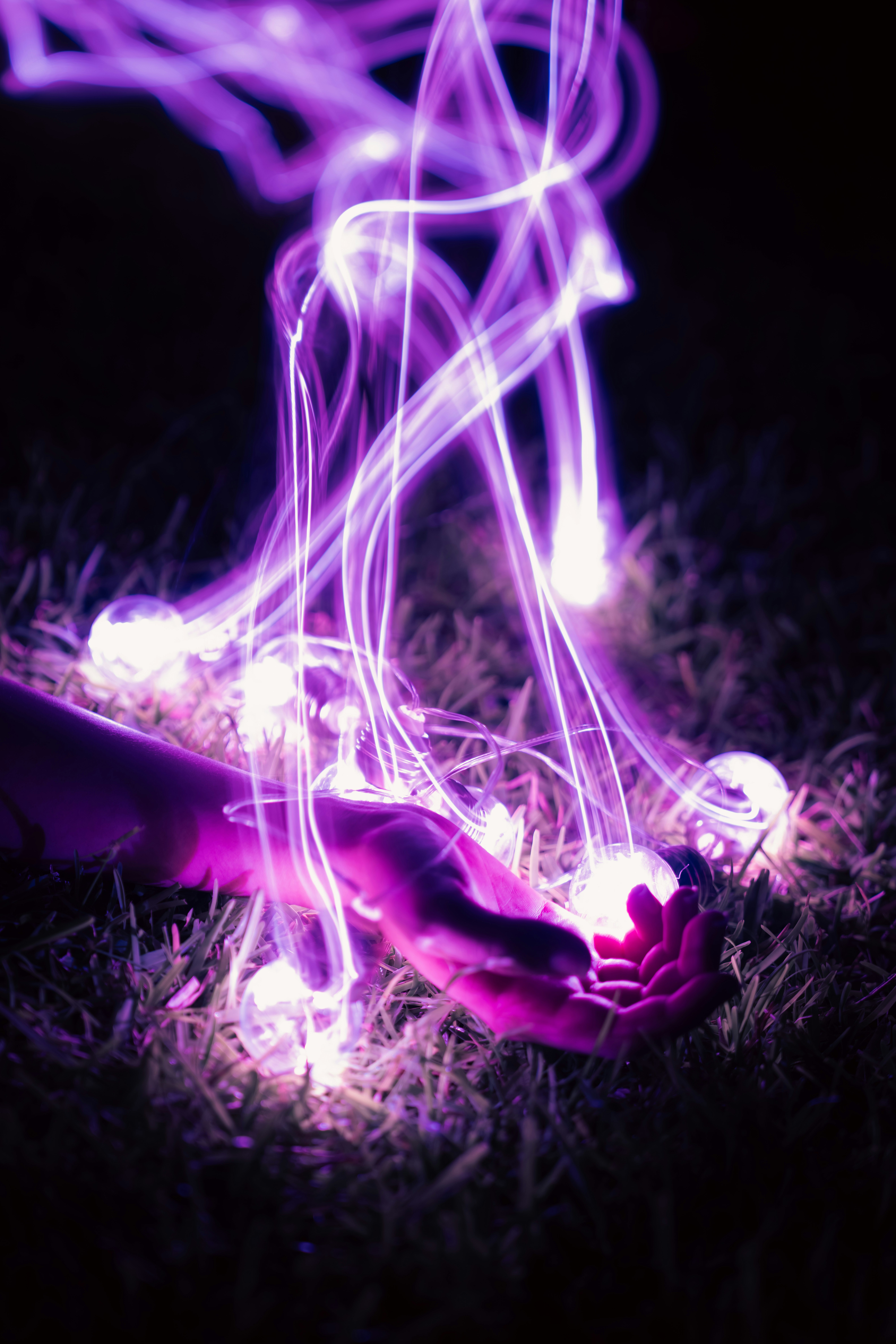 A person holding a lit object in their hand photo – Free Lighting Image ...