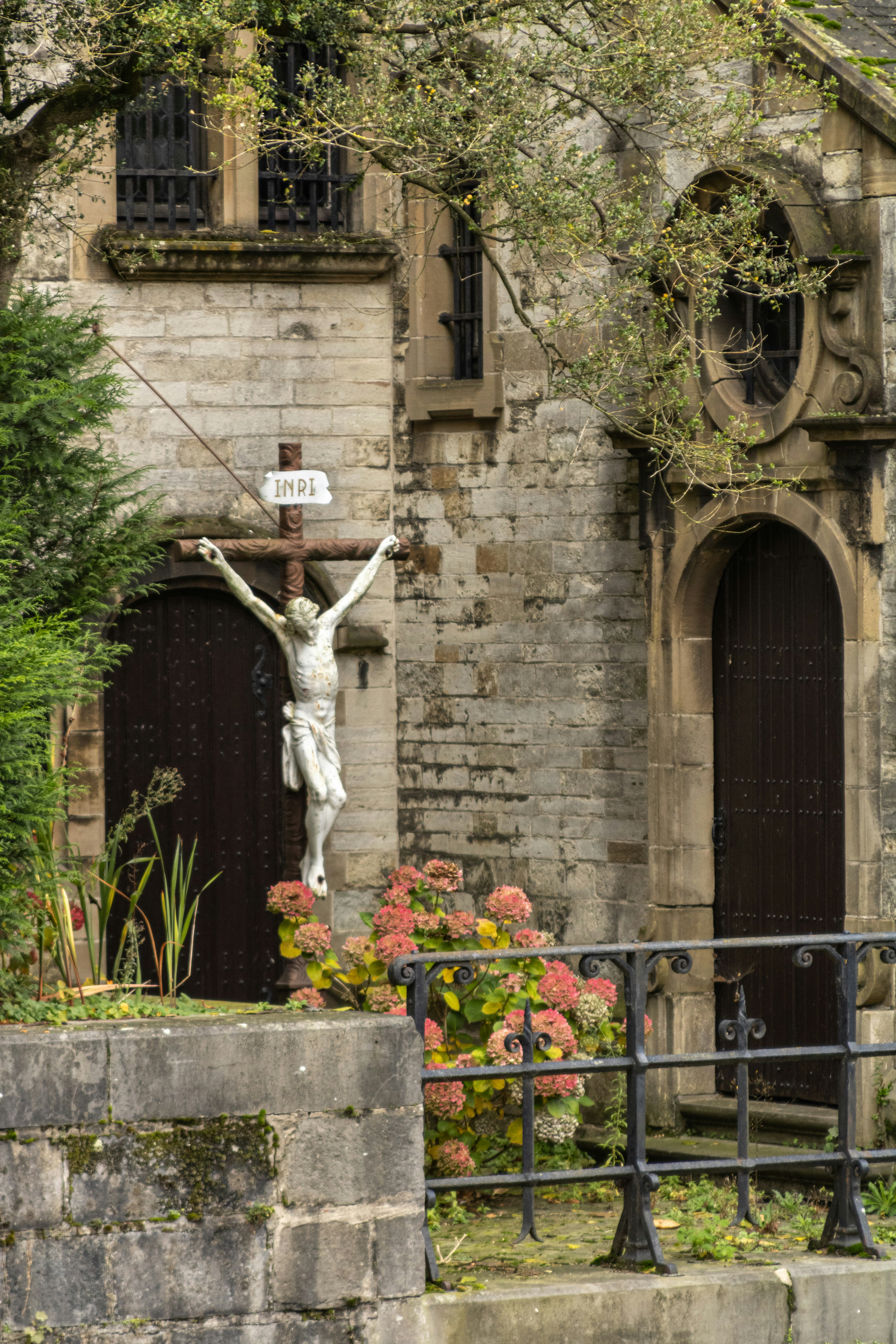 Crucifix Courtyard: Stonework, Ivy, and Blushing Hydrangeas