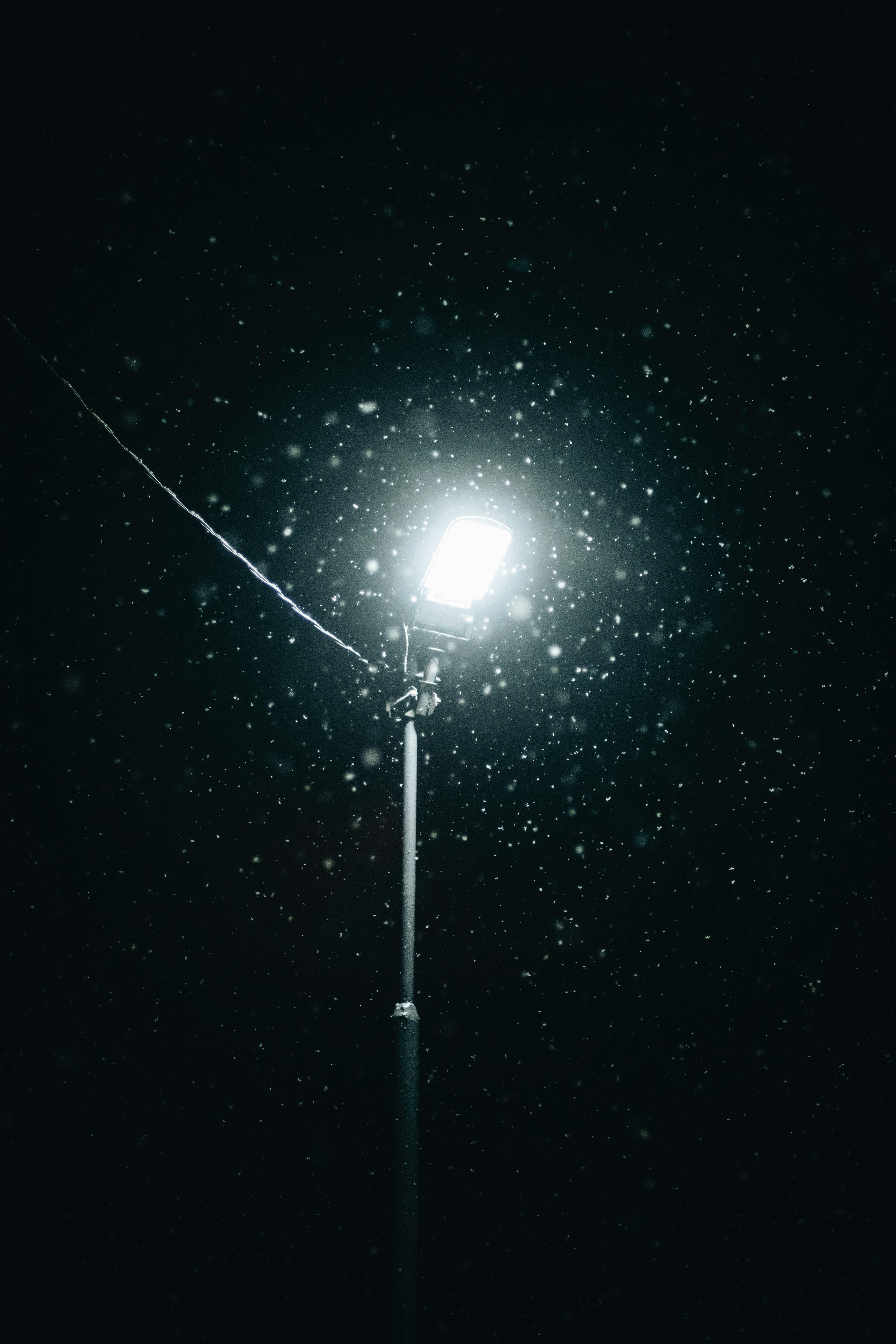 A street light in the dark with snow falling on it photo – Free Night ...