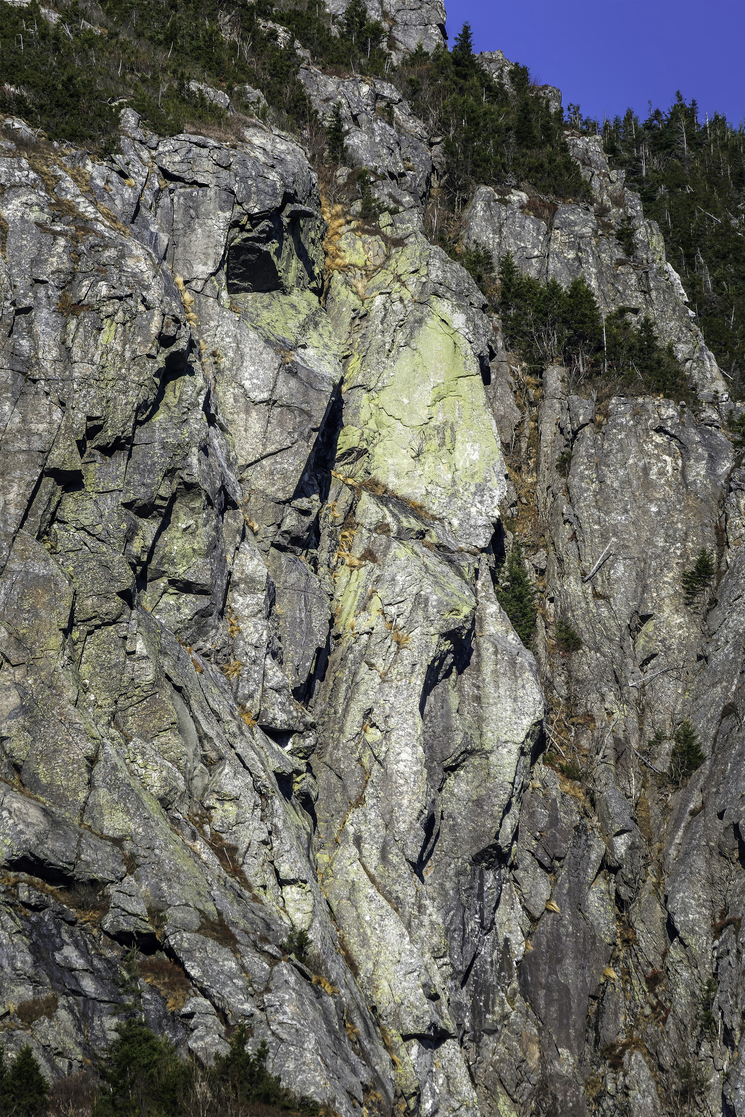 A mountain side with a very tall rock face photo – Free Franconia Image ...