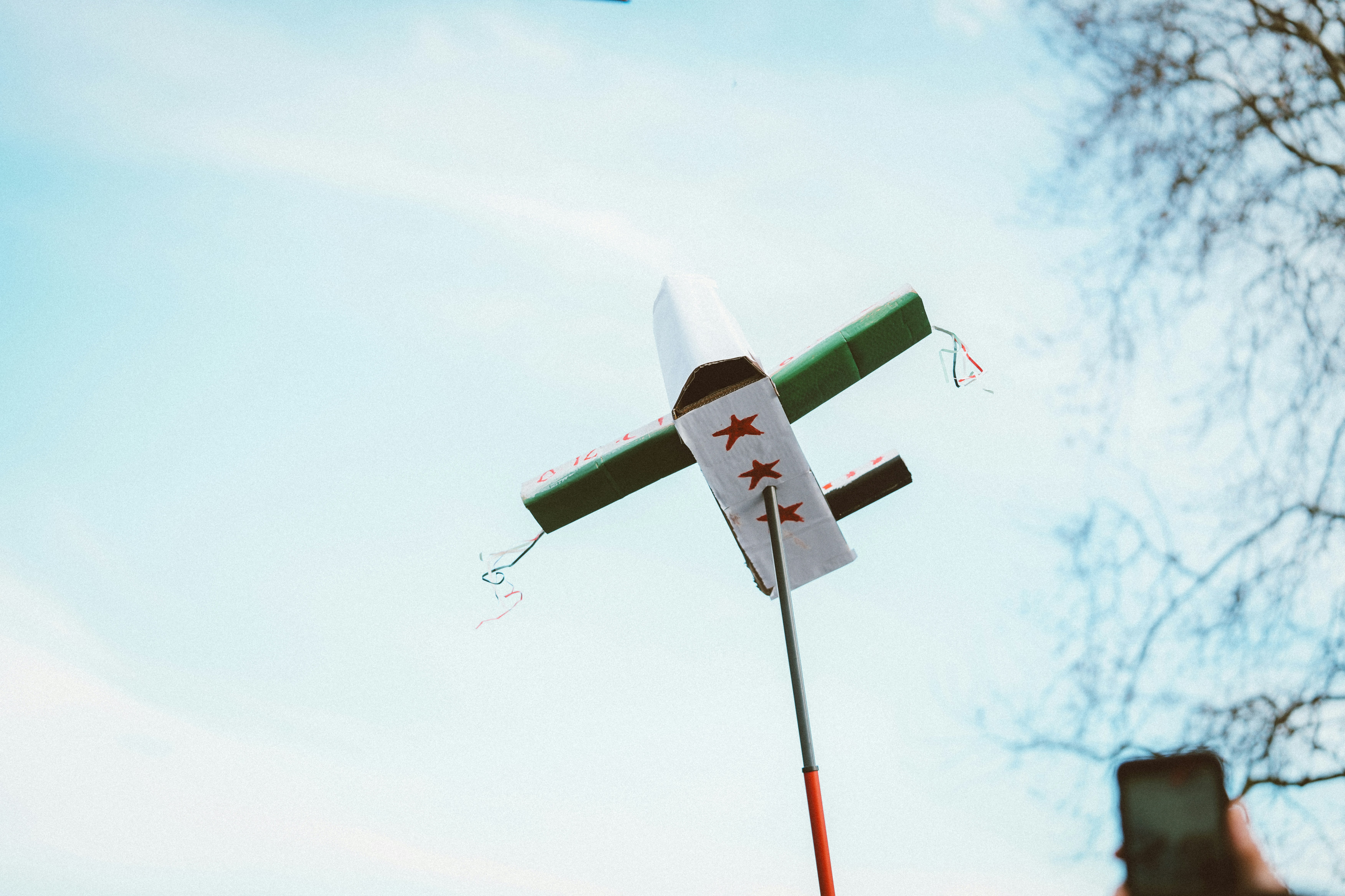 Miniature Skyplane: A Toy Biplane Cleaves the Bright Blue