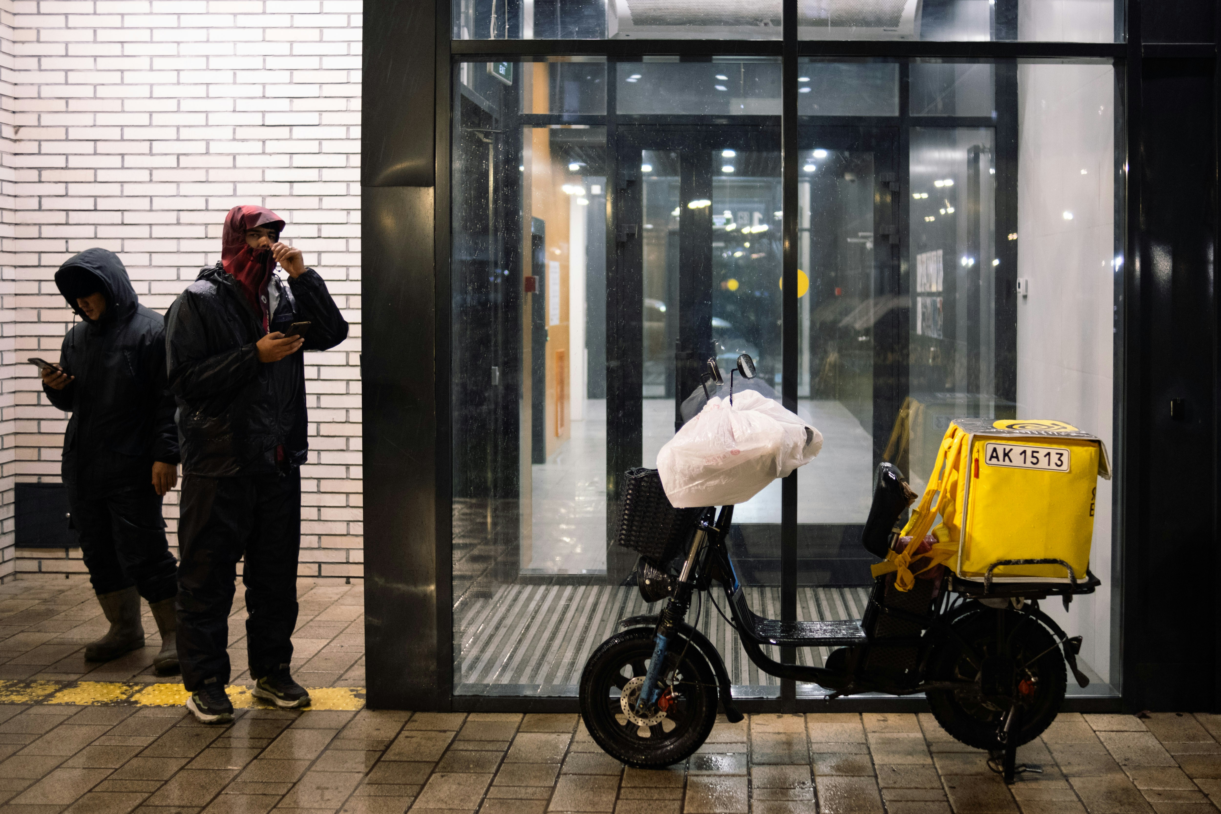 Midnight Courier: A Cargo E-Bike Resting at a Glass-Front Storefront
