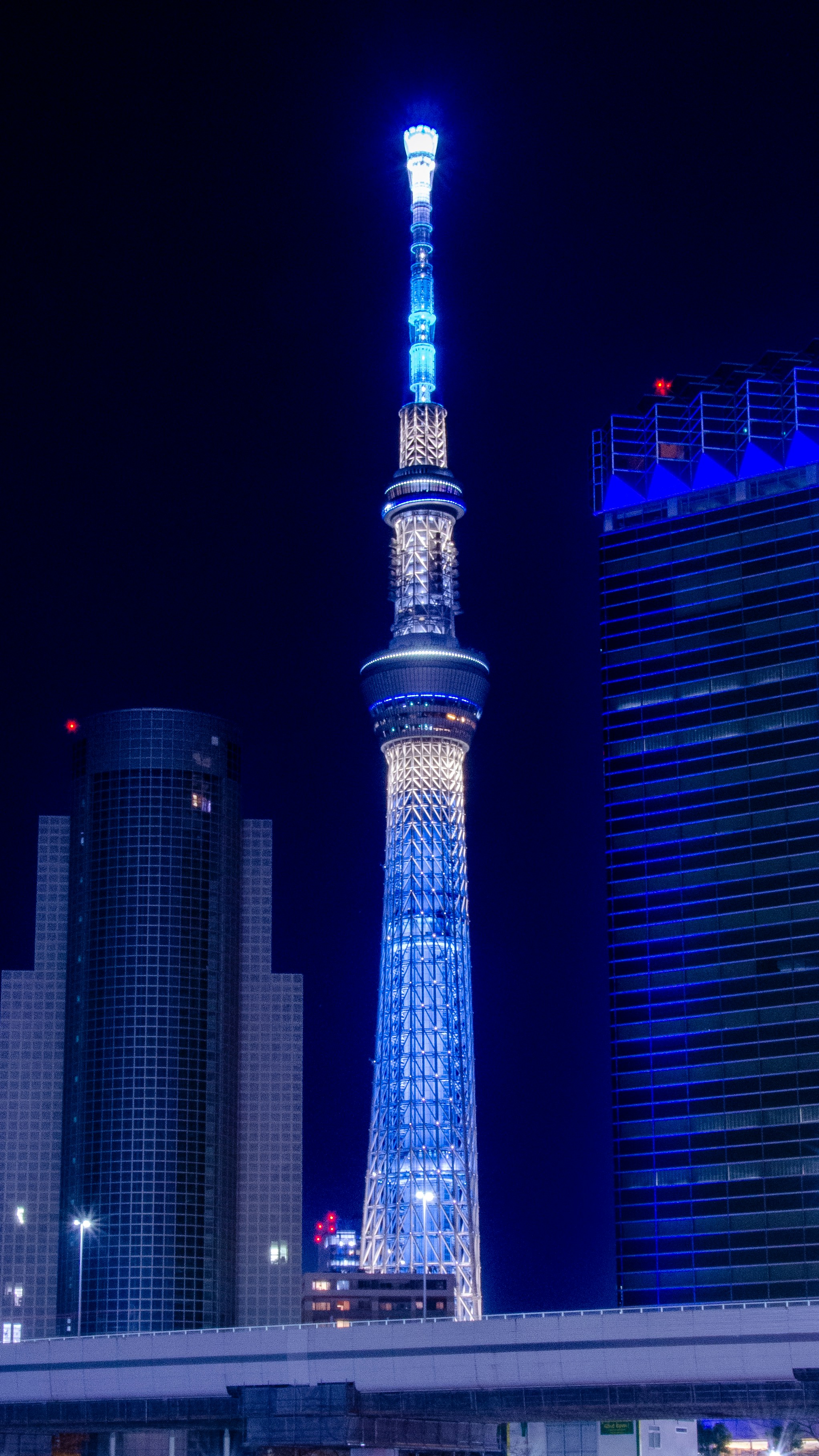 A very tall building with a very bright light on it's side