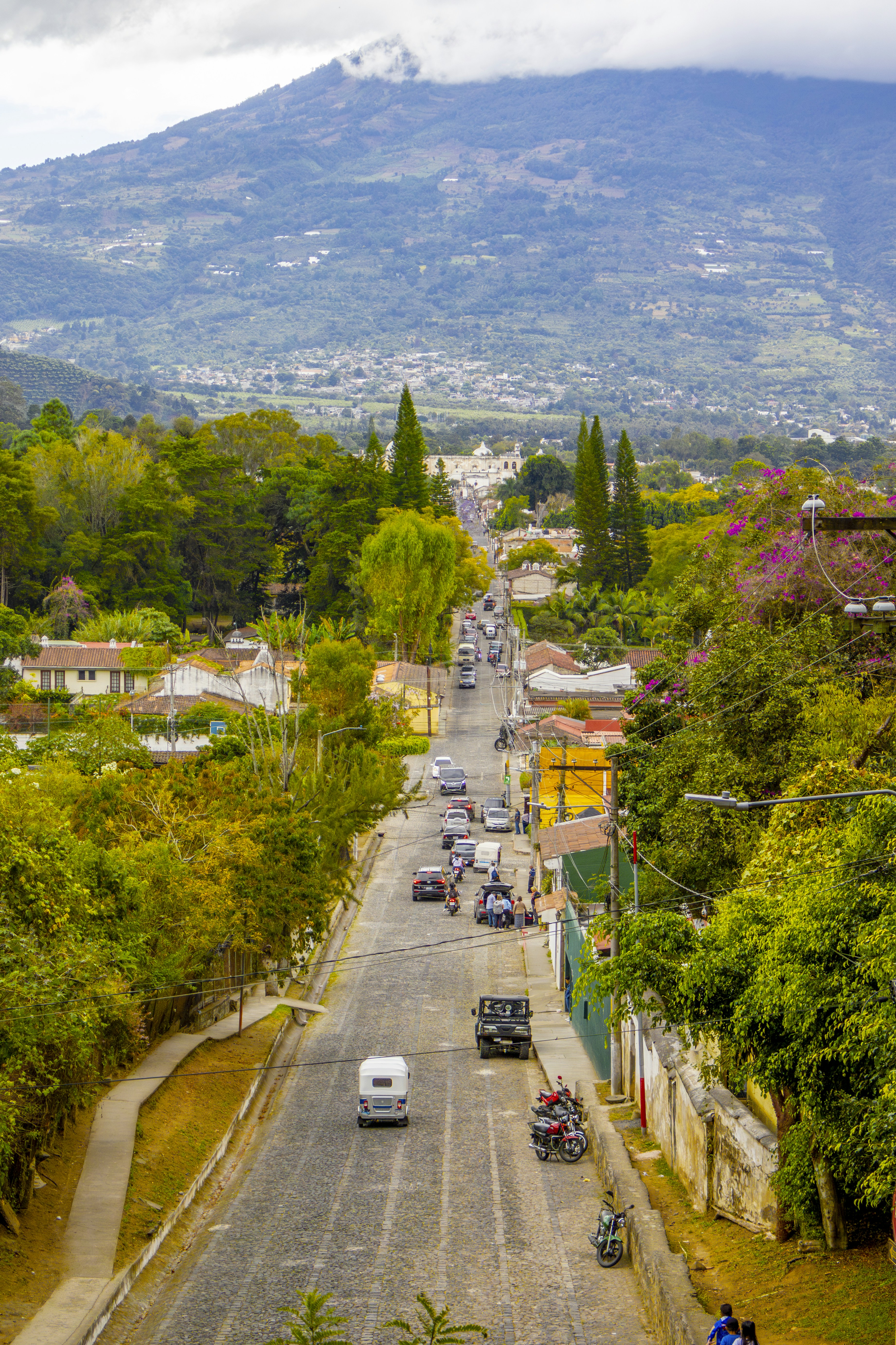 Downhill Cobblestone Boulevard: A Colorful Town Descends Toward the Mountains