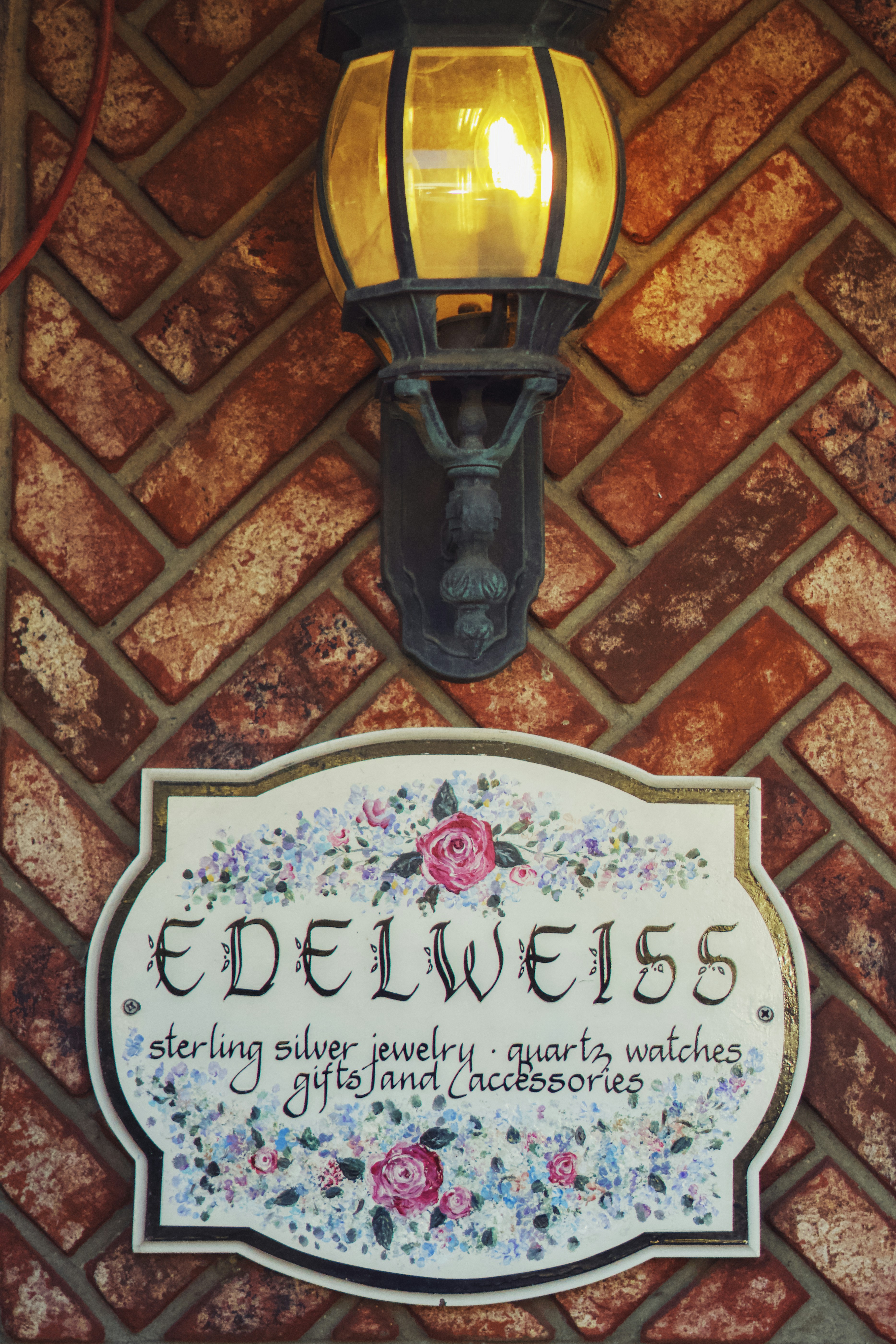 Glow of the Lantern Above Edelweiss: A Facade Sign in Brick Air