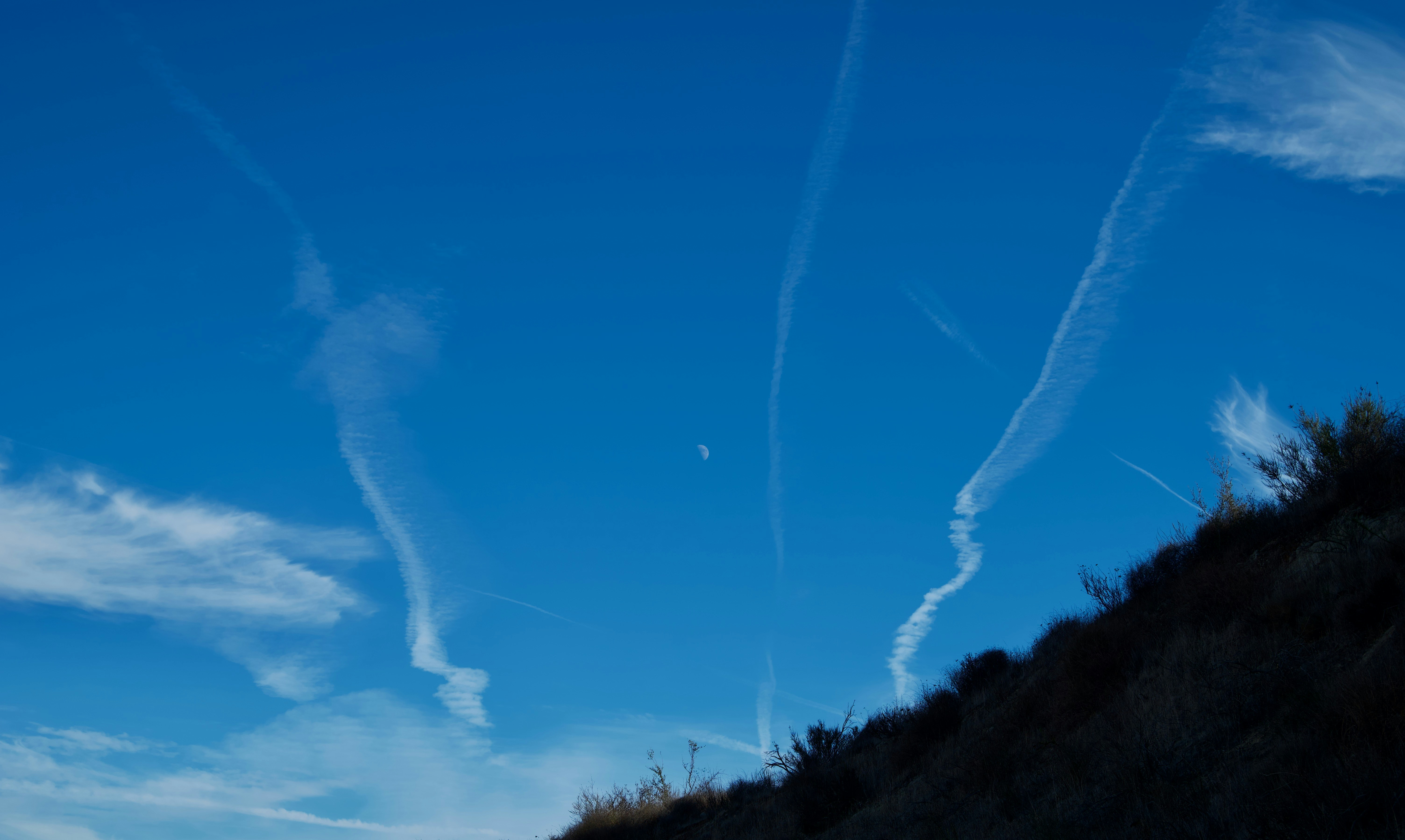 Moon in a Contrail Quilt Above the Ridge