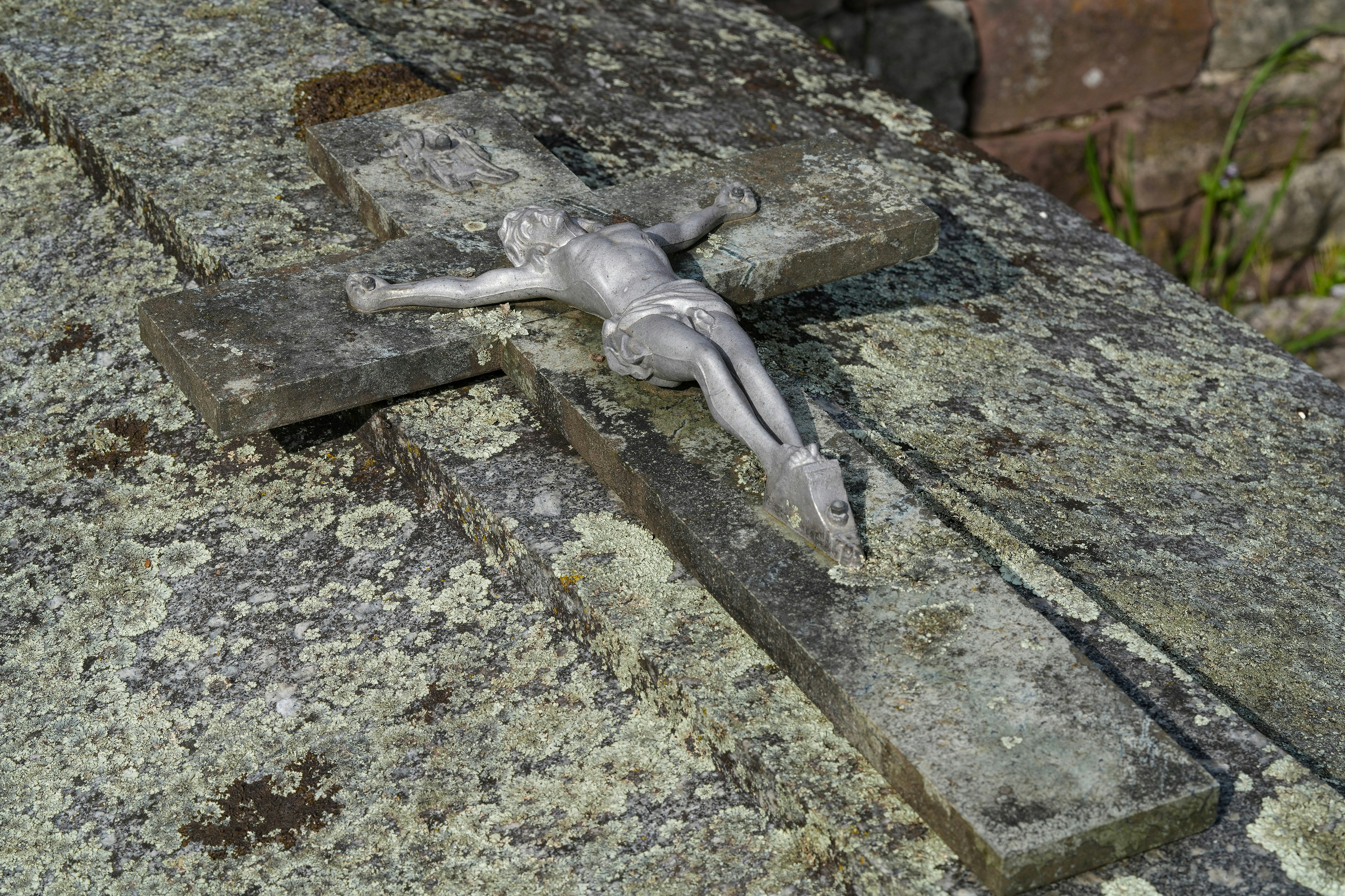 A statue of a person laying on top of a rock photo – Free Jesus Image ...