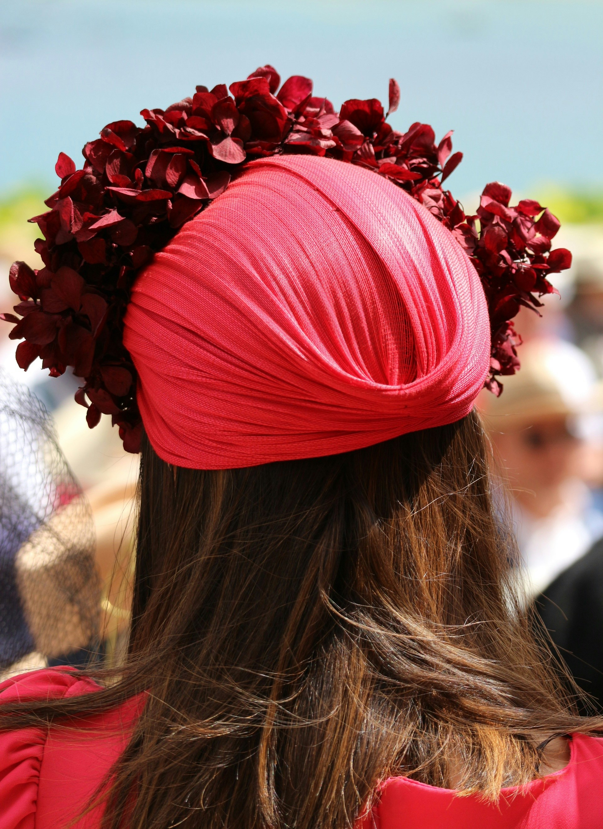 Crimson Crown of Petals: A Turbaned Portrait from Behind