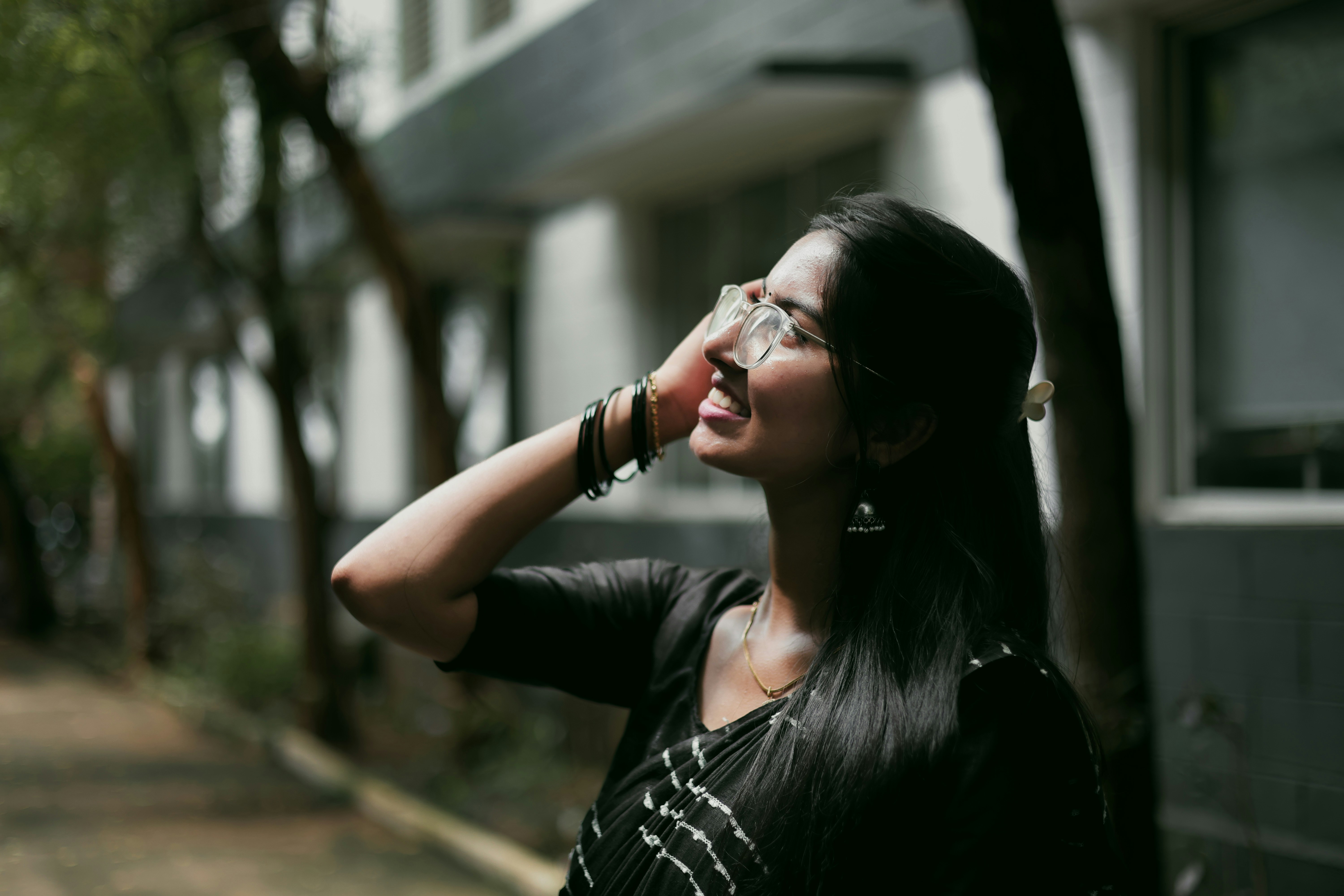 A woman talking on a cell phone next to a building photo – Free Woman ...