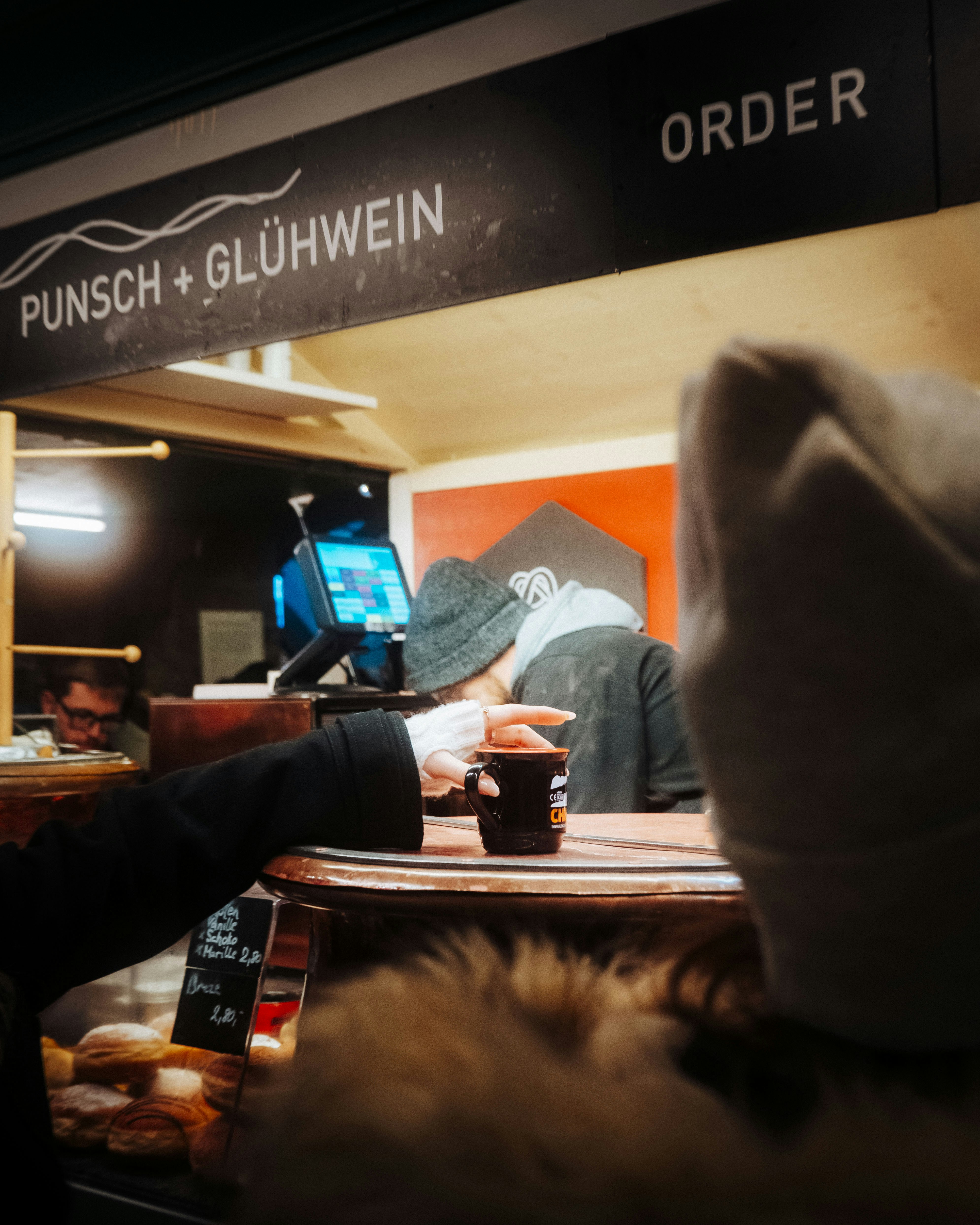 Midnight Café Gesture: A Barista’s Hand Reaches for a Cup under Warm Neon Lights