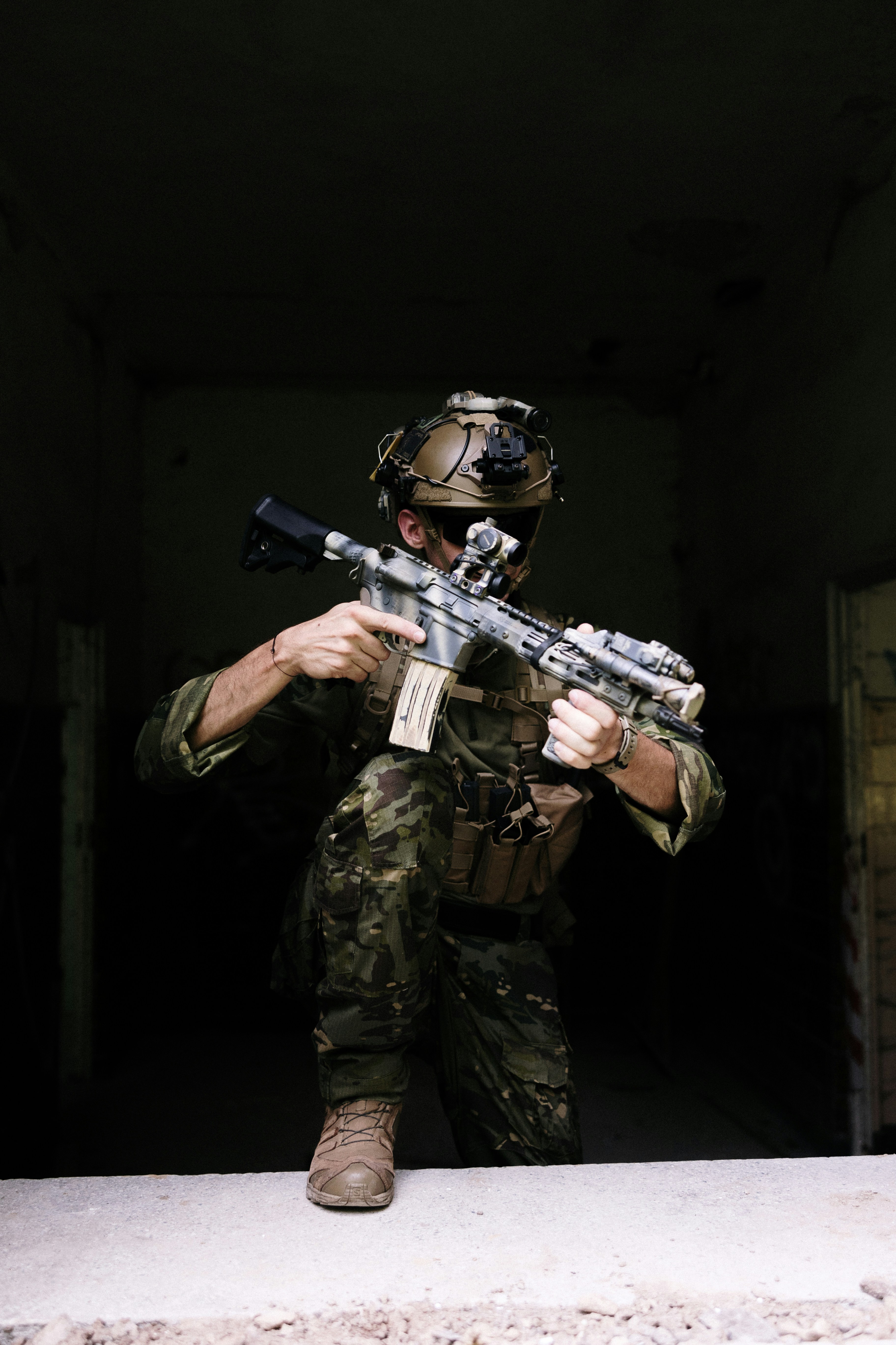 A man in camouflage holding a machine gun photo – Free Man Image on ...