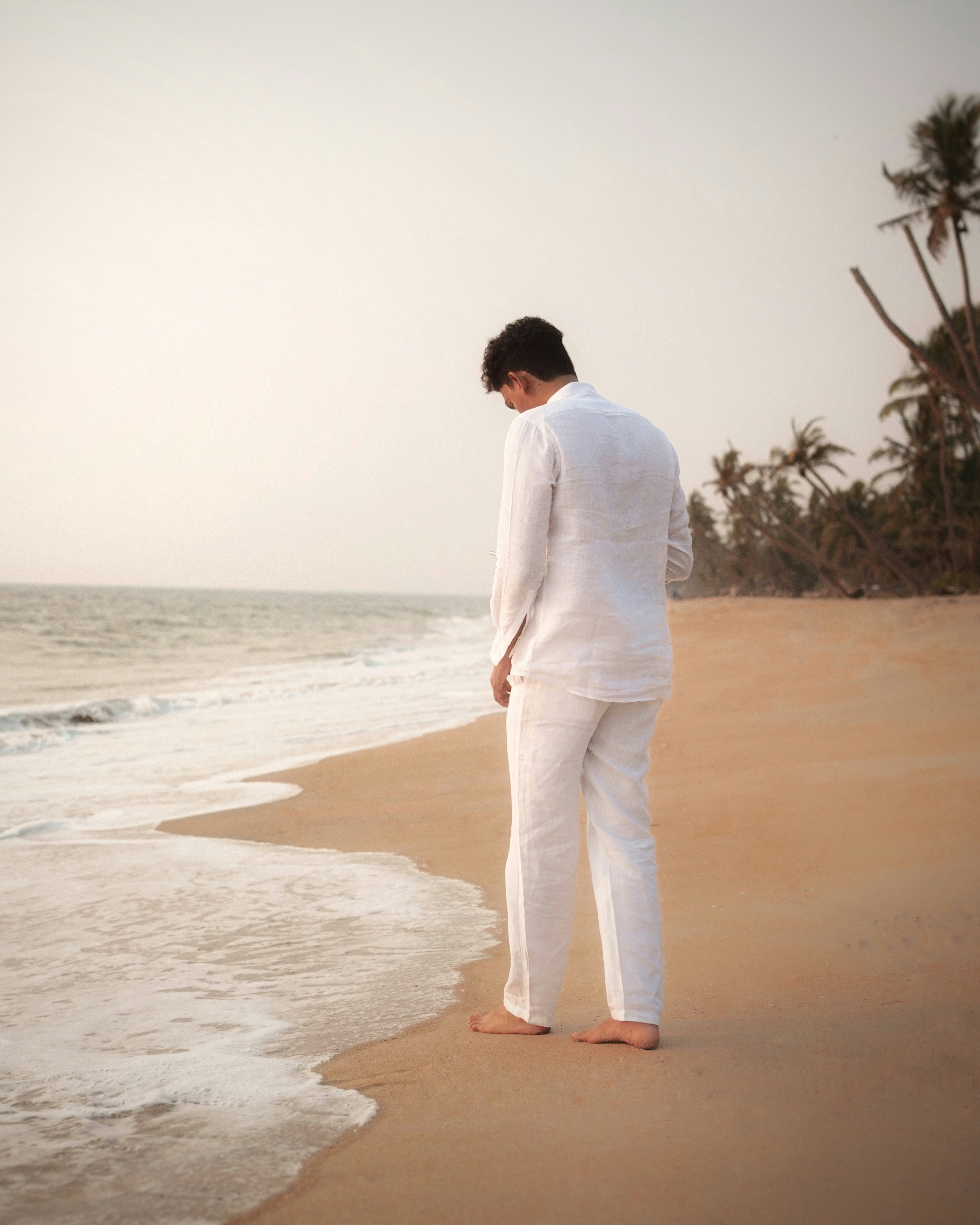 Solitary on the Shore: A White Linen Portrait at Dusk