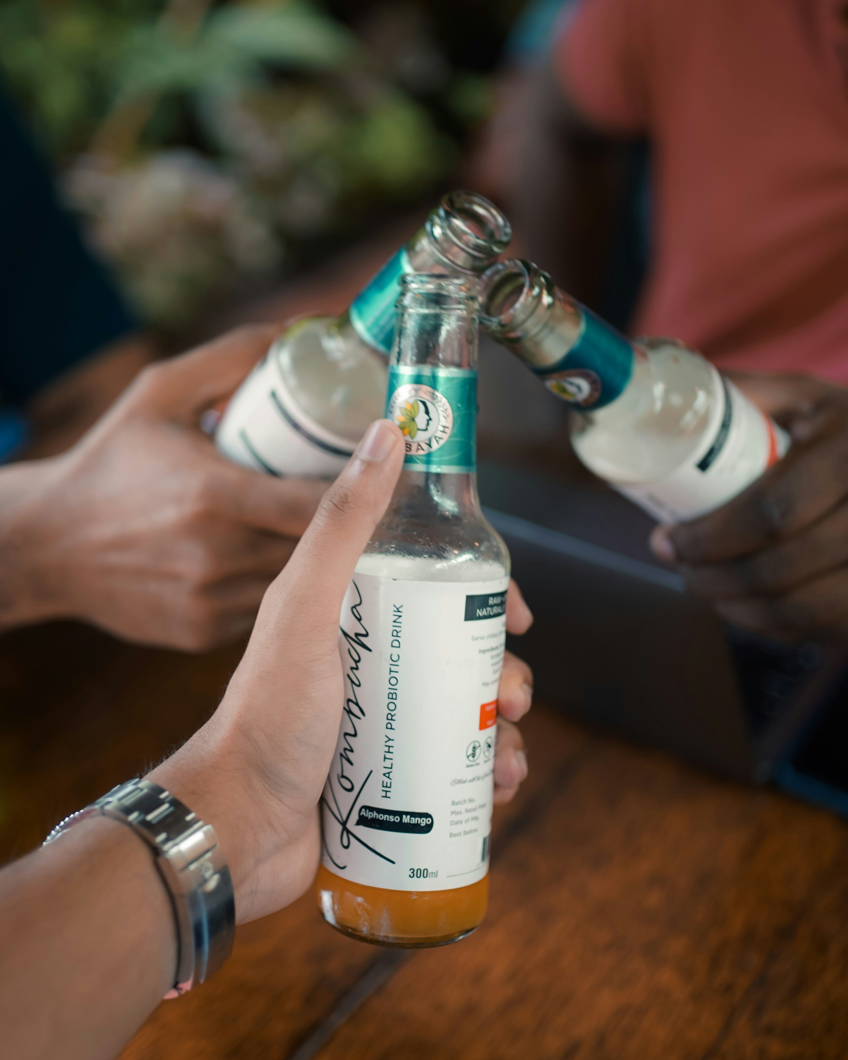 A person holding a bottle of beer in their hand