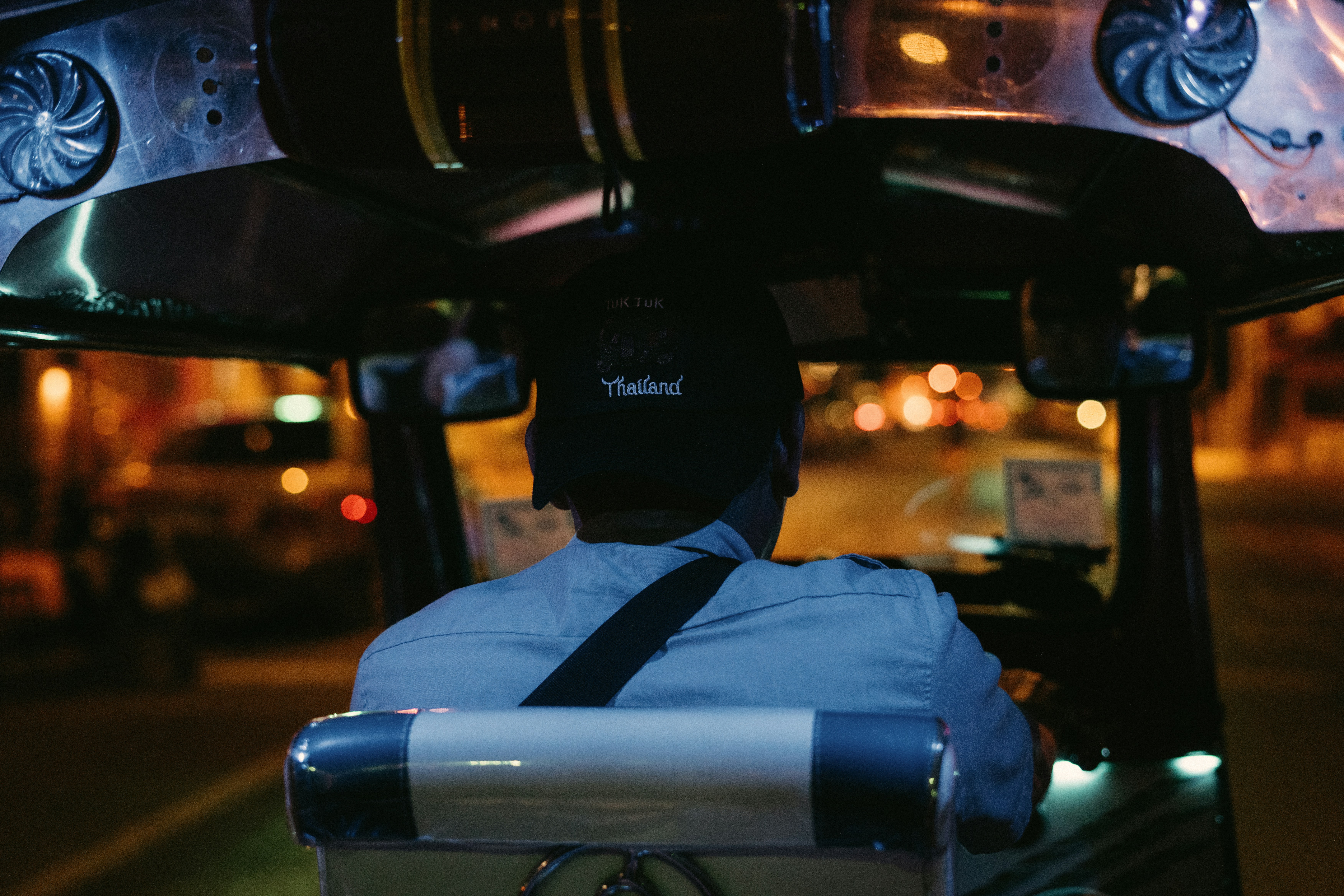 Night Ride in Bangkok Tuk-Tuk: Neon Glow and a Driver's Back