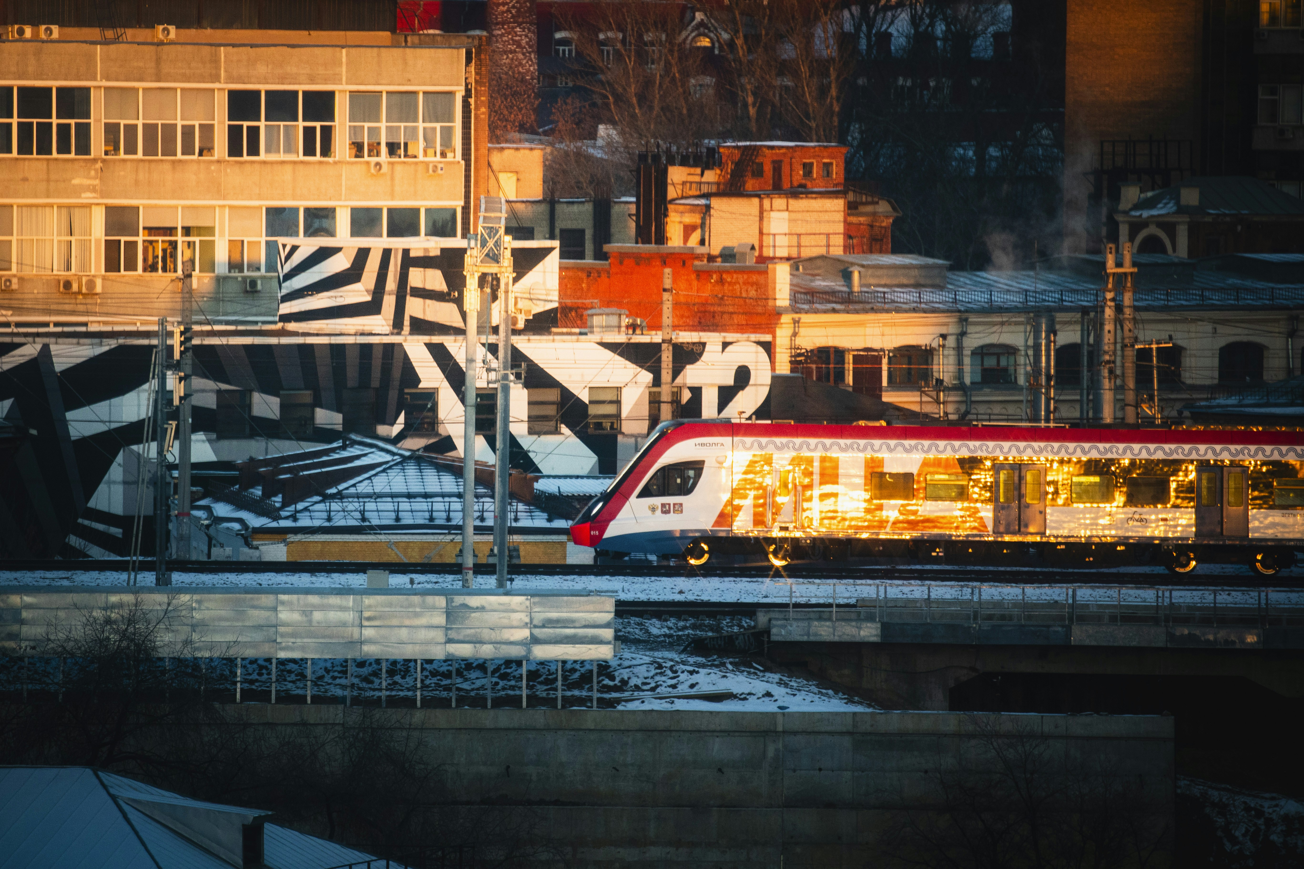 Golden Hour Glide: Red-Nosed Train Through Graffiti Corridor