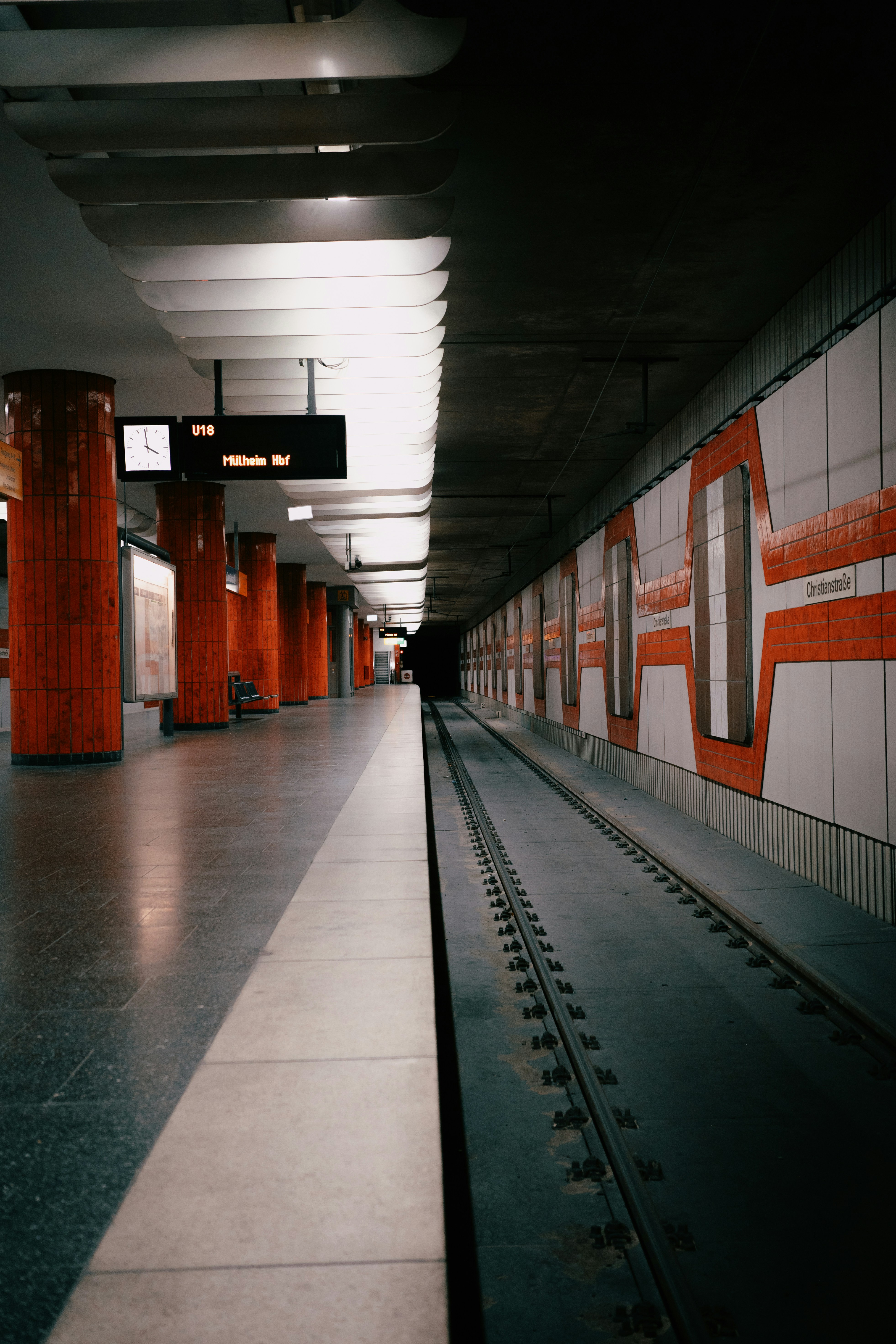 A train station with a long line of train tracks photo – Free Street ...