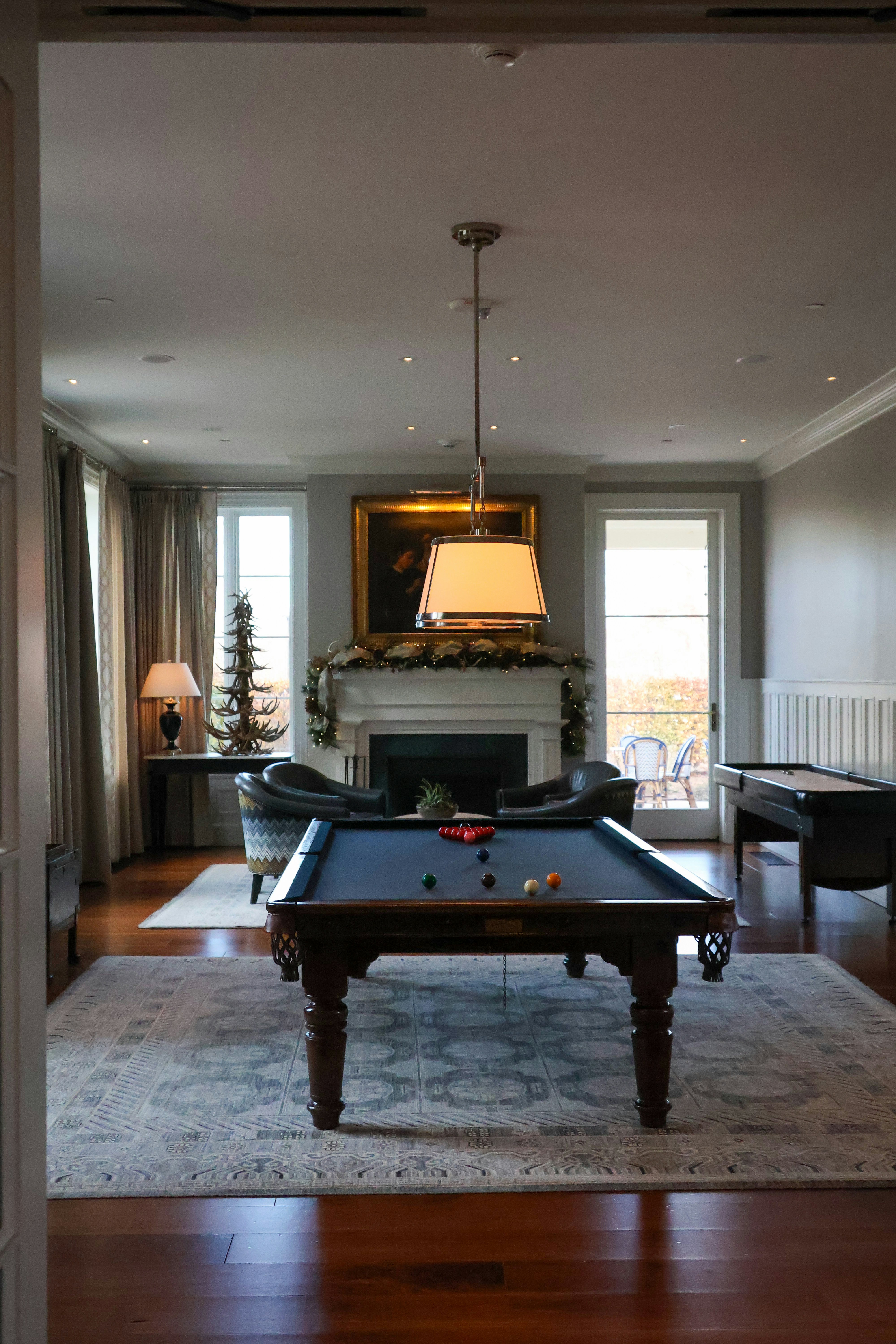 A pool table in a living room with a fireplace photo – Free Keswick ...