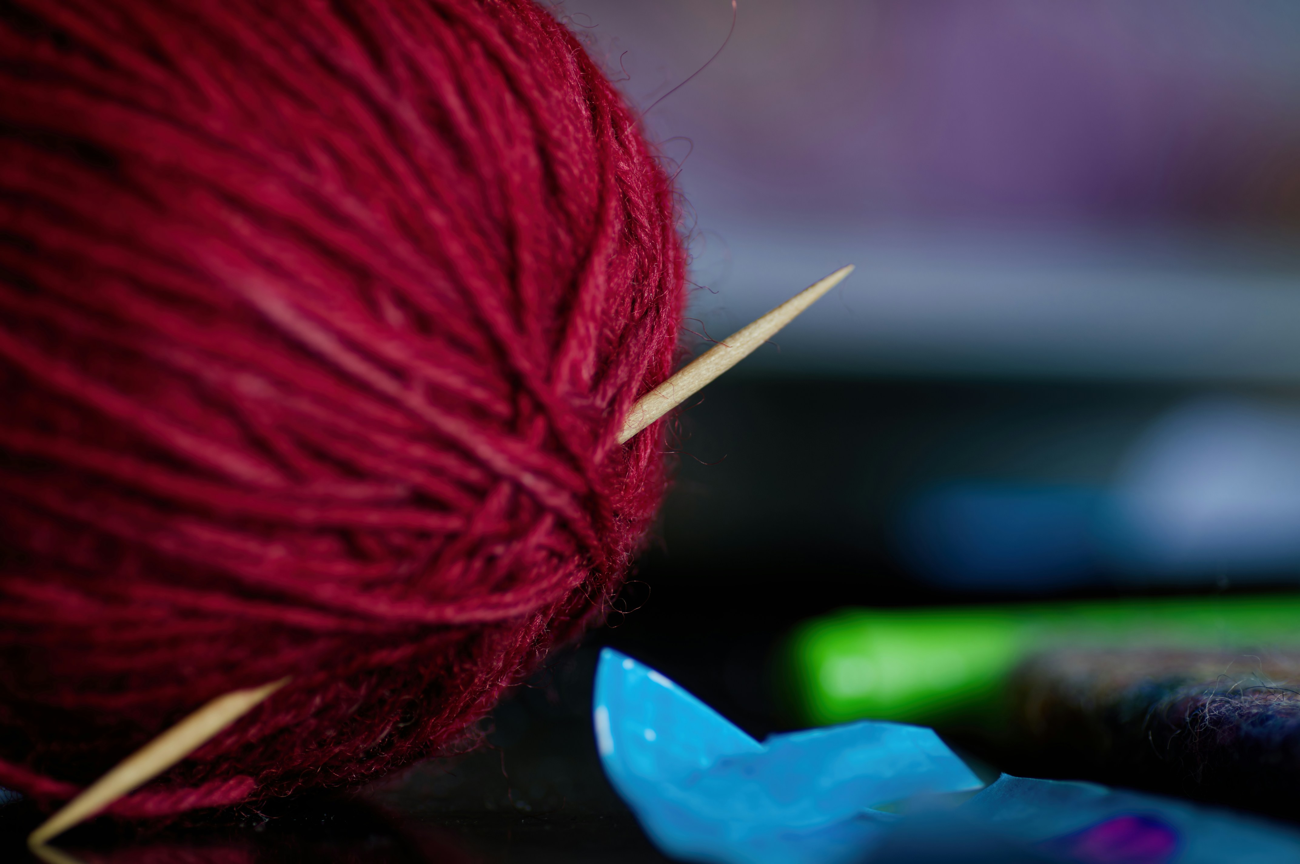 A close up of a ball of yarn and a pair of scissors