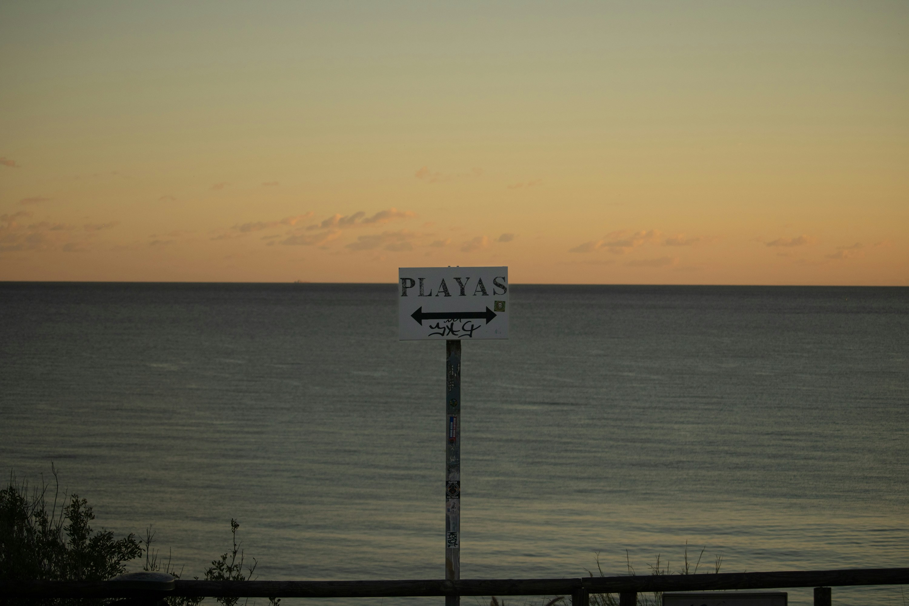 Playas Signpost at Dusk Over a Serene Sea