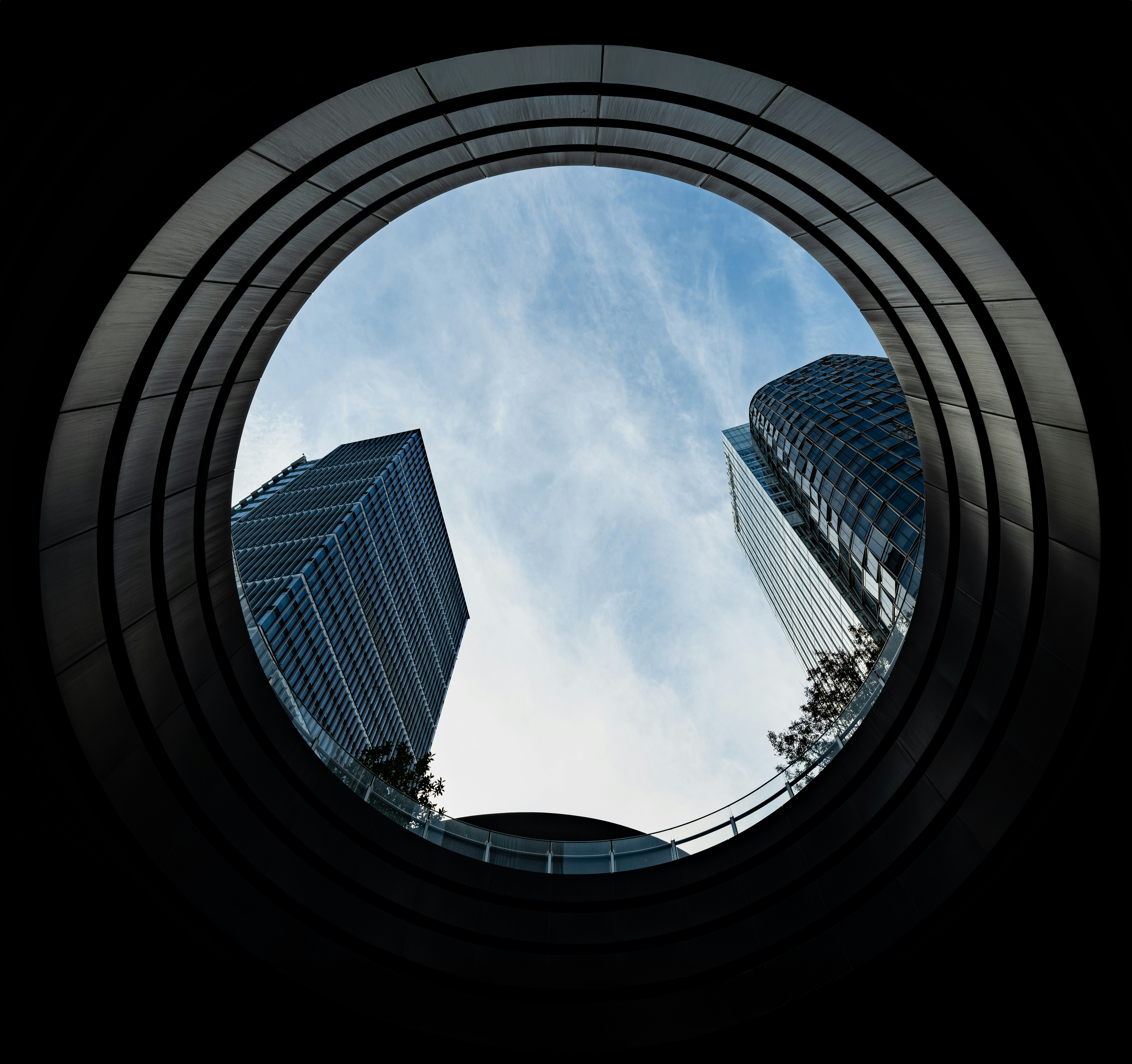 A view of a building through a circular window photo – Free Xuhui ...
