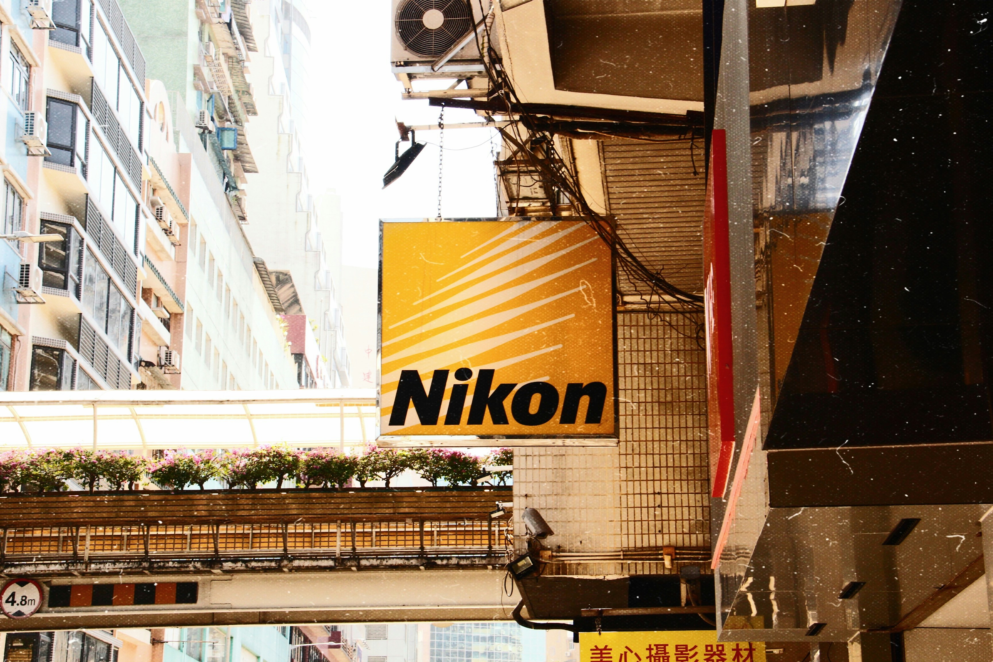 A street sign hanging from the side of a building photo – Free Shot on ...