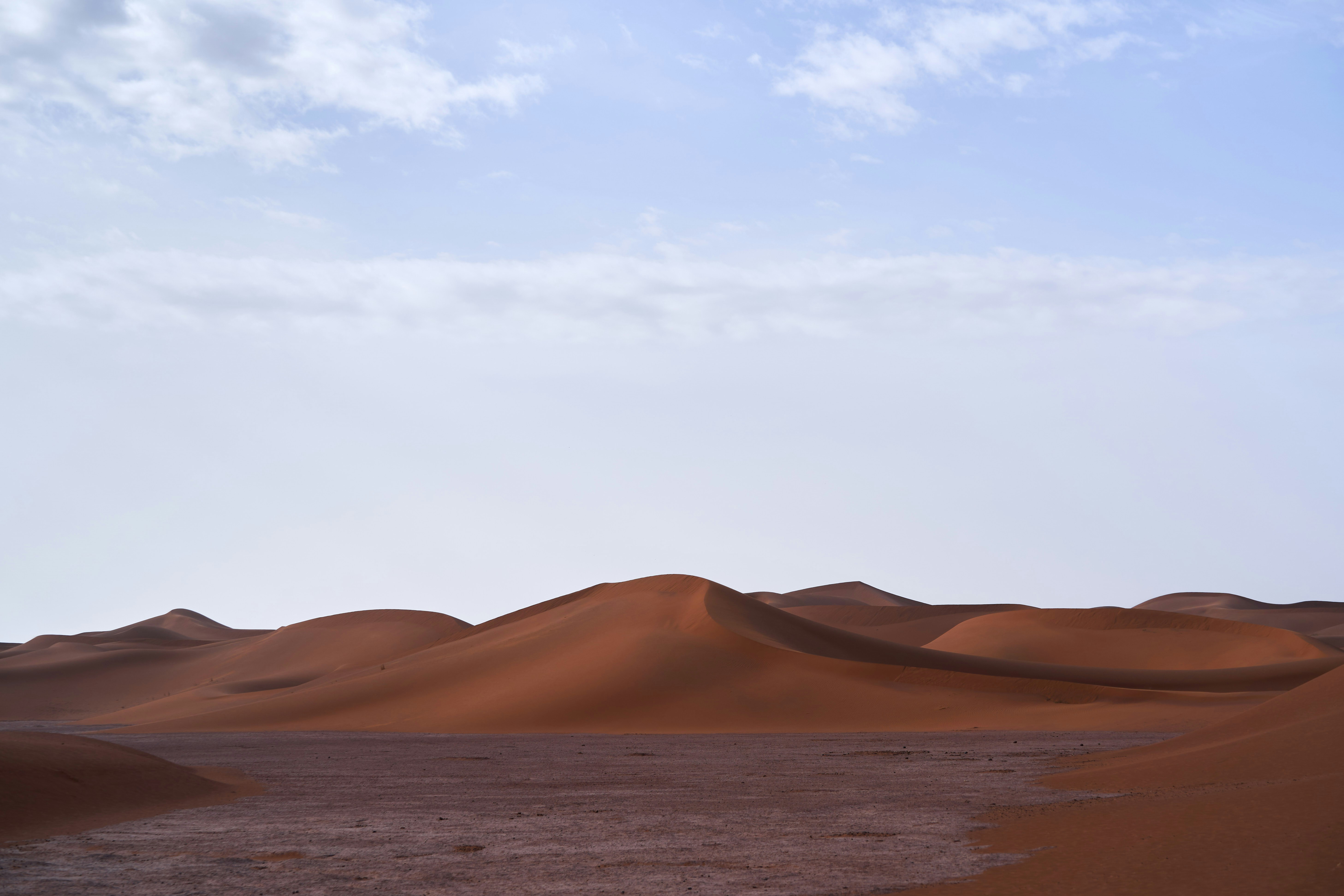 A group of people walking across a desert photo – Free Desert Image on Unsplash