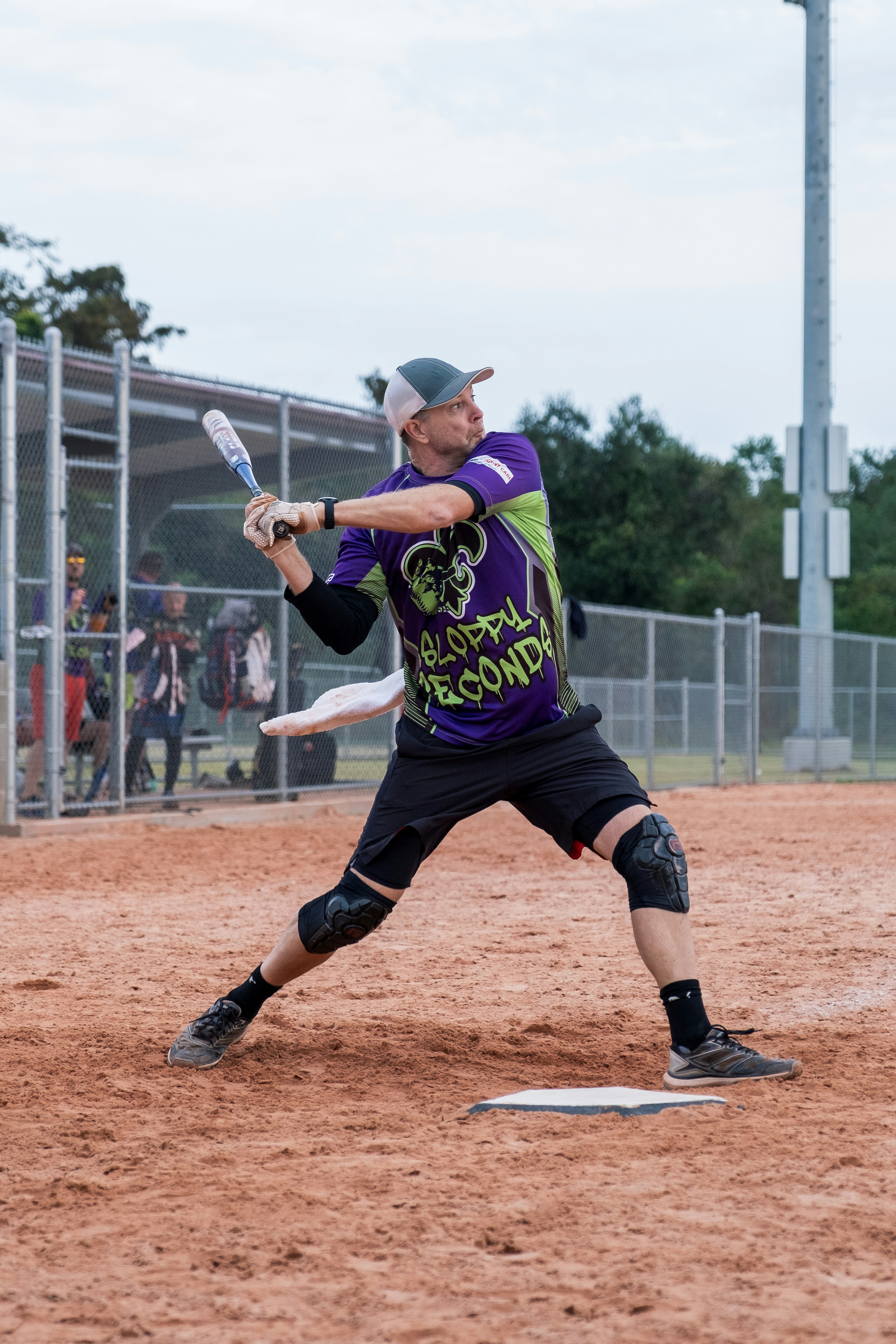 Swing Through the Dirt: Purple Jersey Batter at the Plate