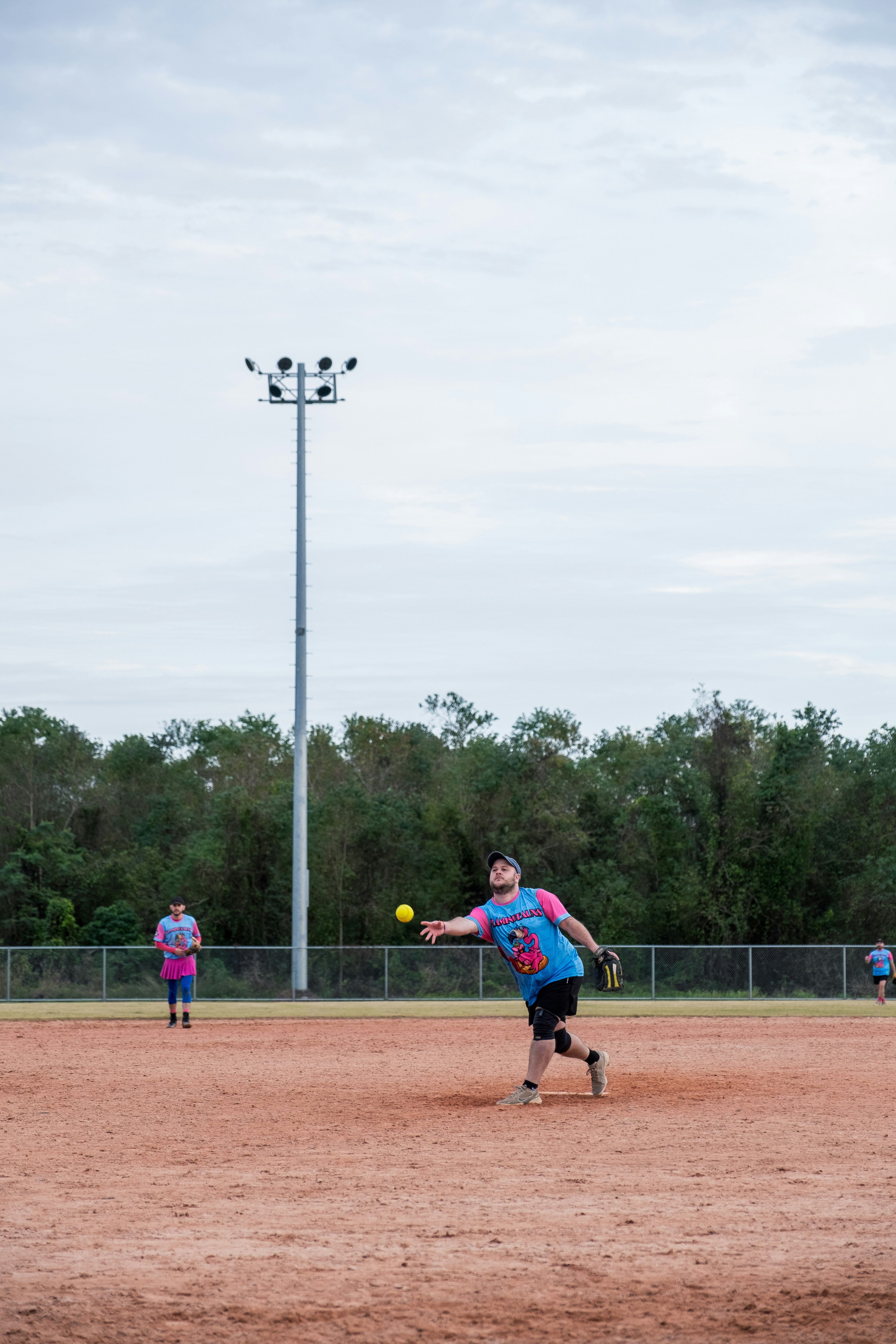 Dusty Diamond Throw: A Youth Pitch on the Quiet Field