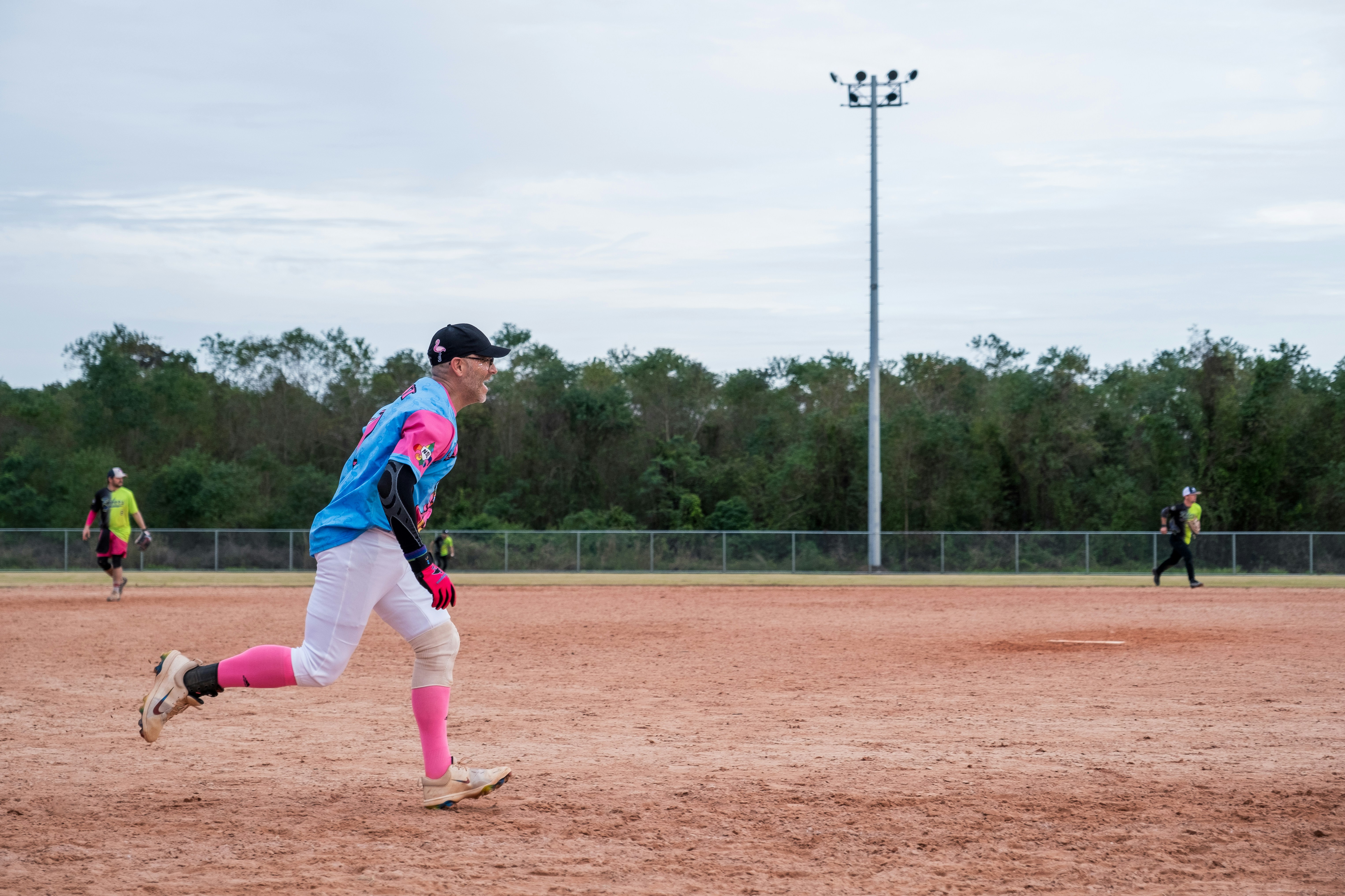 A baseball player running across a baseball field photo – Free Girl ...