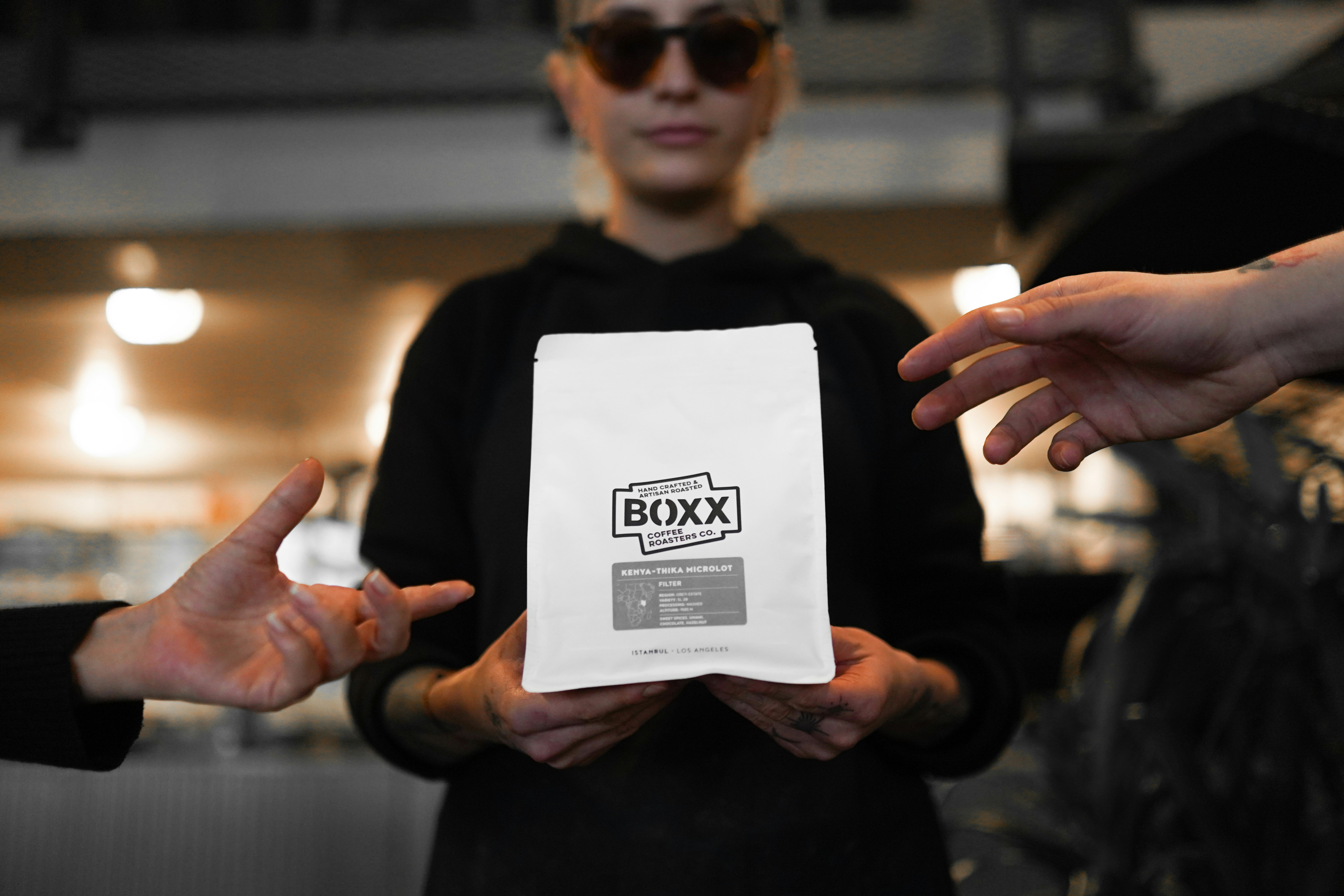 A group of people standing around each other holding a box photo – Free ...